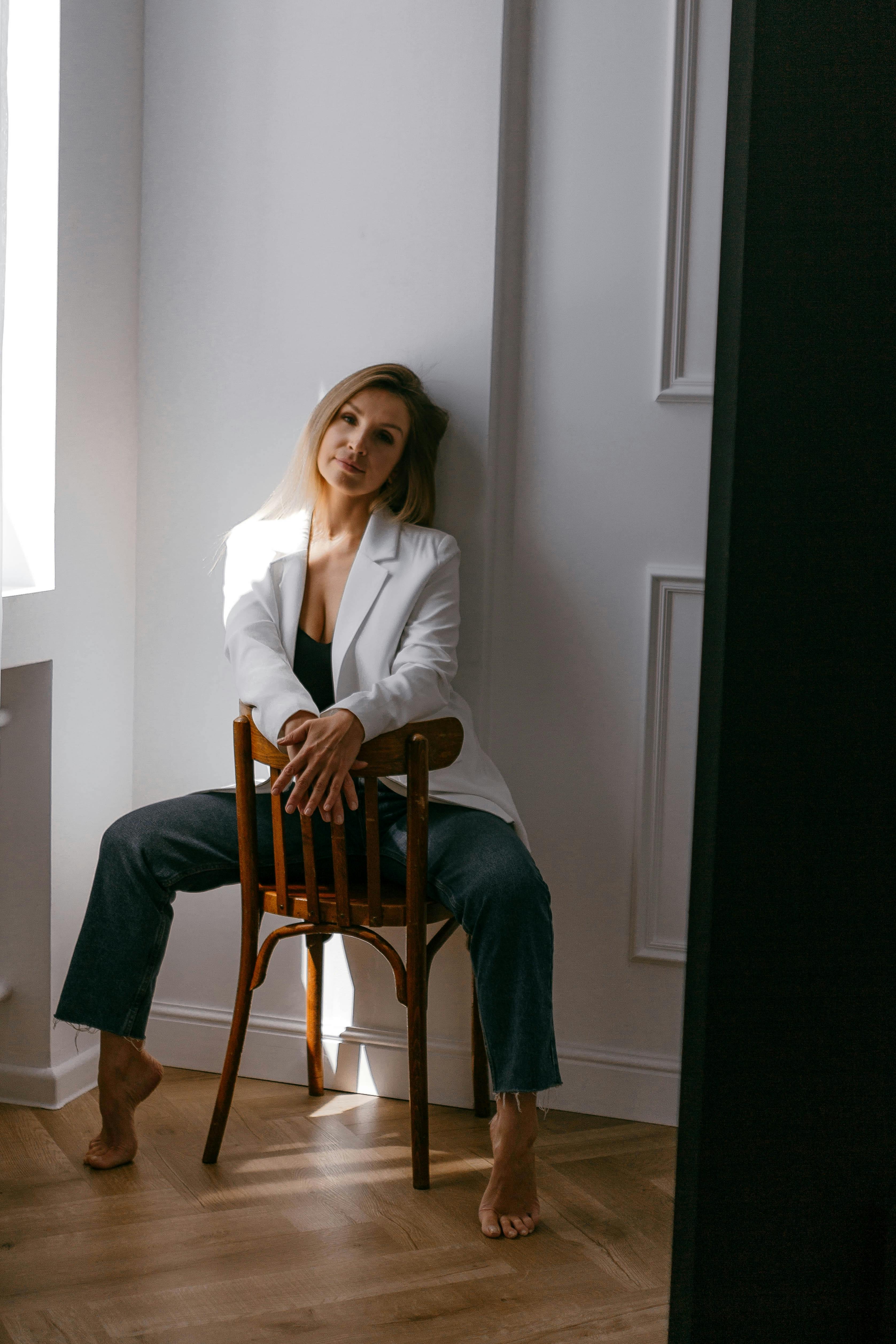 Woman in White Jacket on Chair · Free Stock Photo