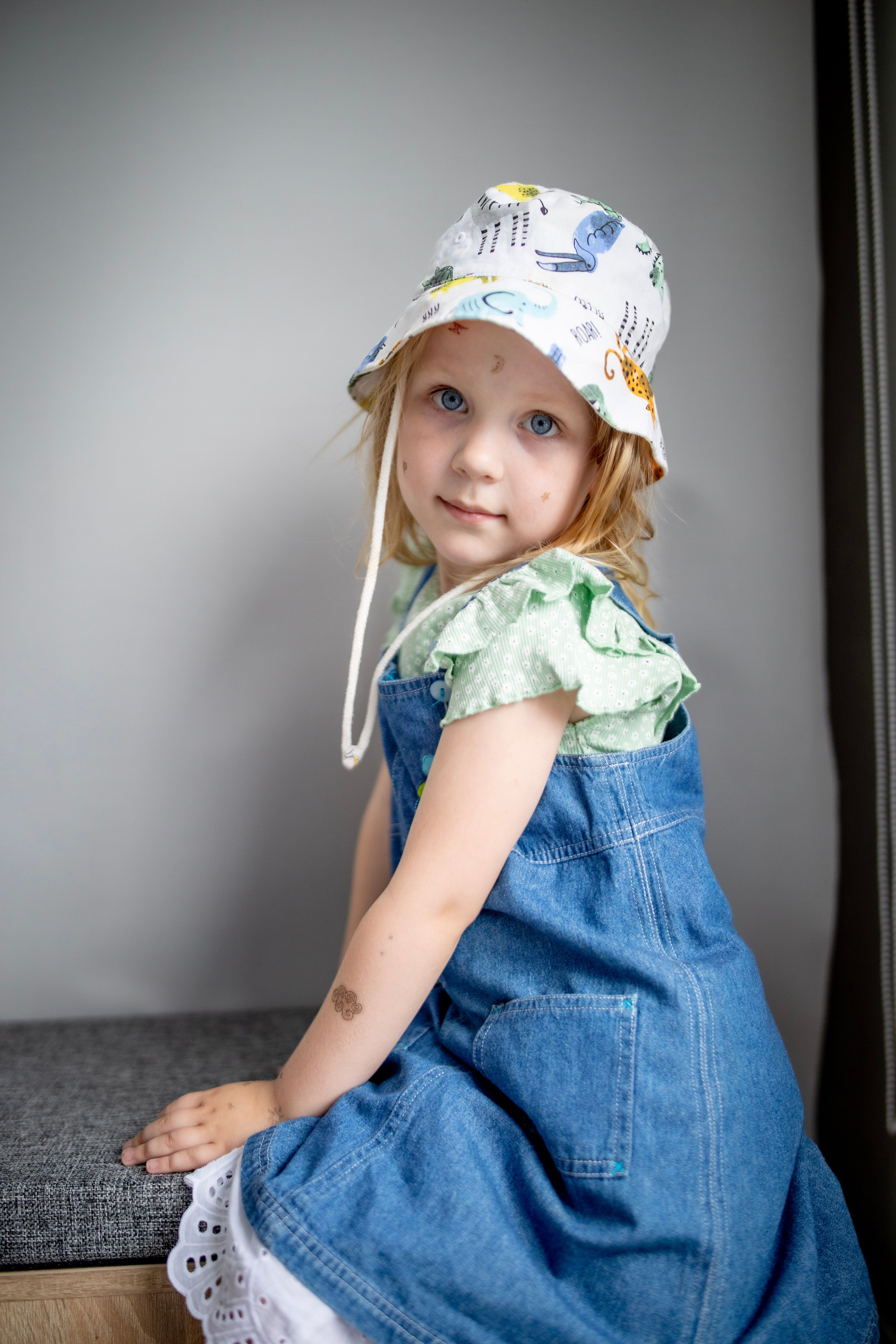 Girl in Bucket Hat and Denim Dress · Free Stock Photo