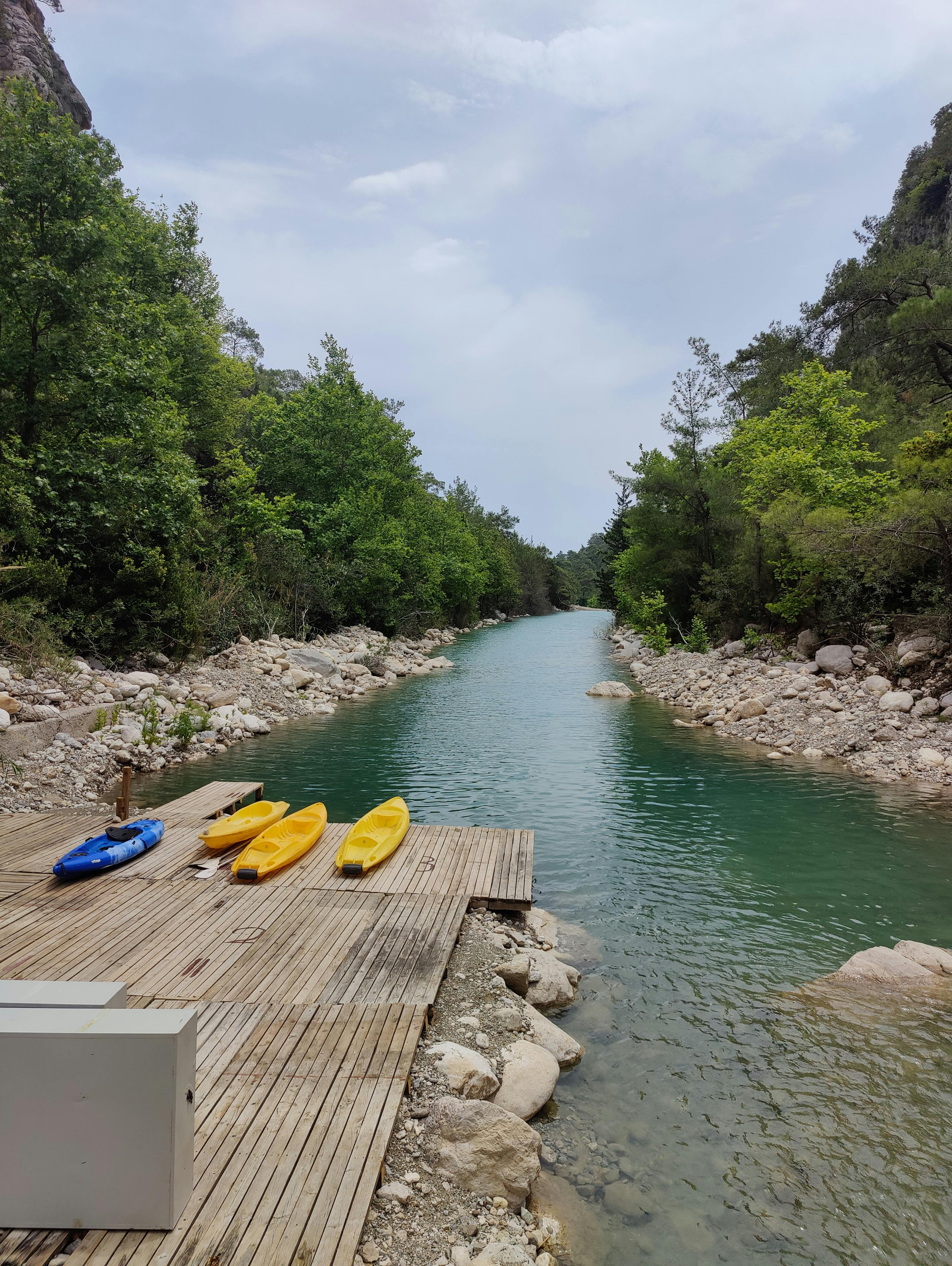 Canoes on a Wooden Platform on the Riverbank · Free Stock Photo