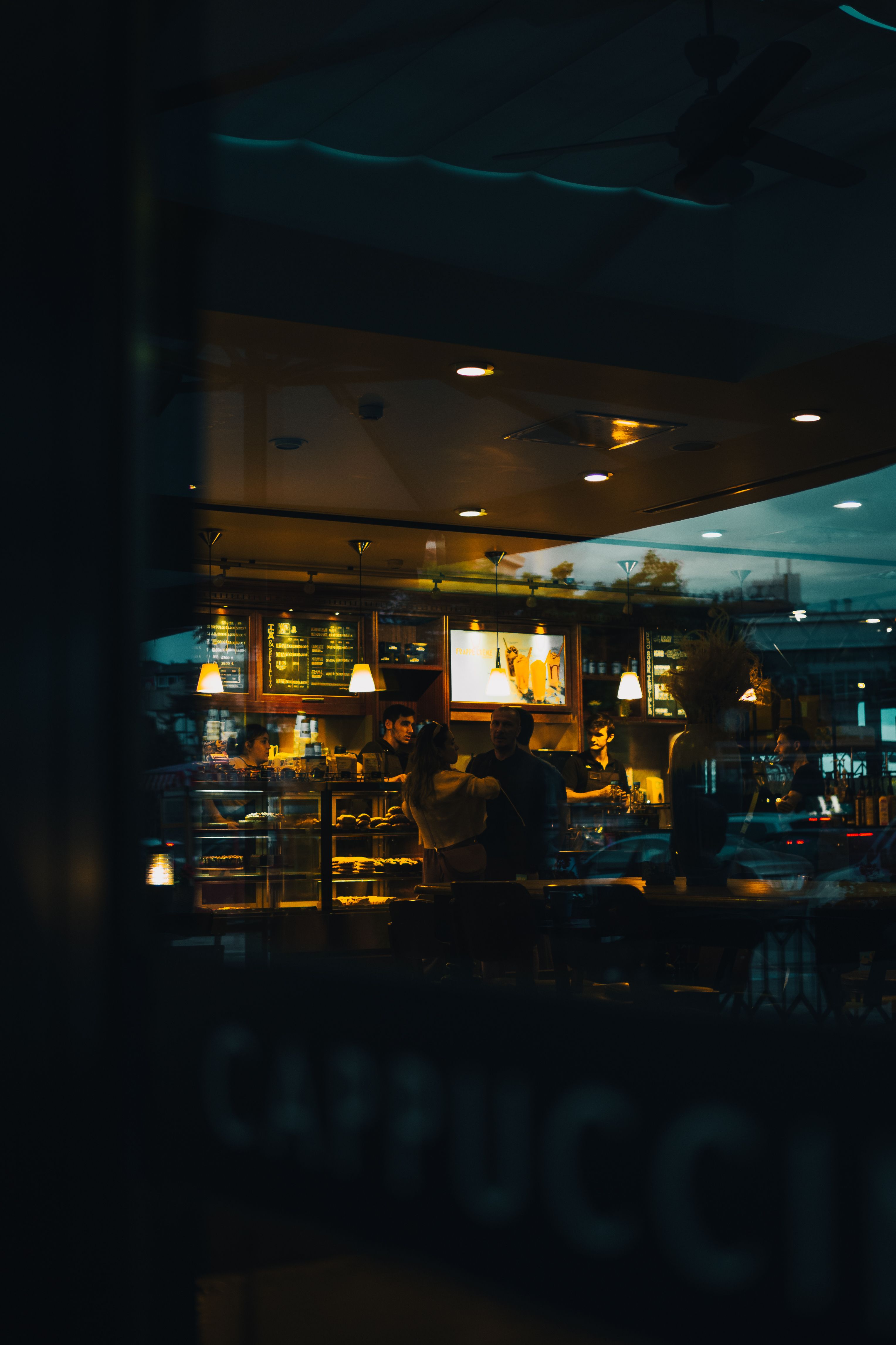 A coffee shop with a window that shows people inside · Free Stock Photo
