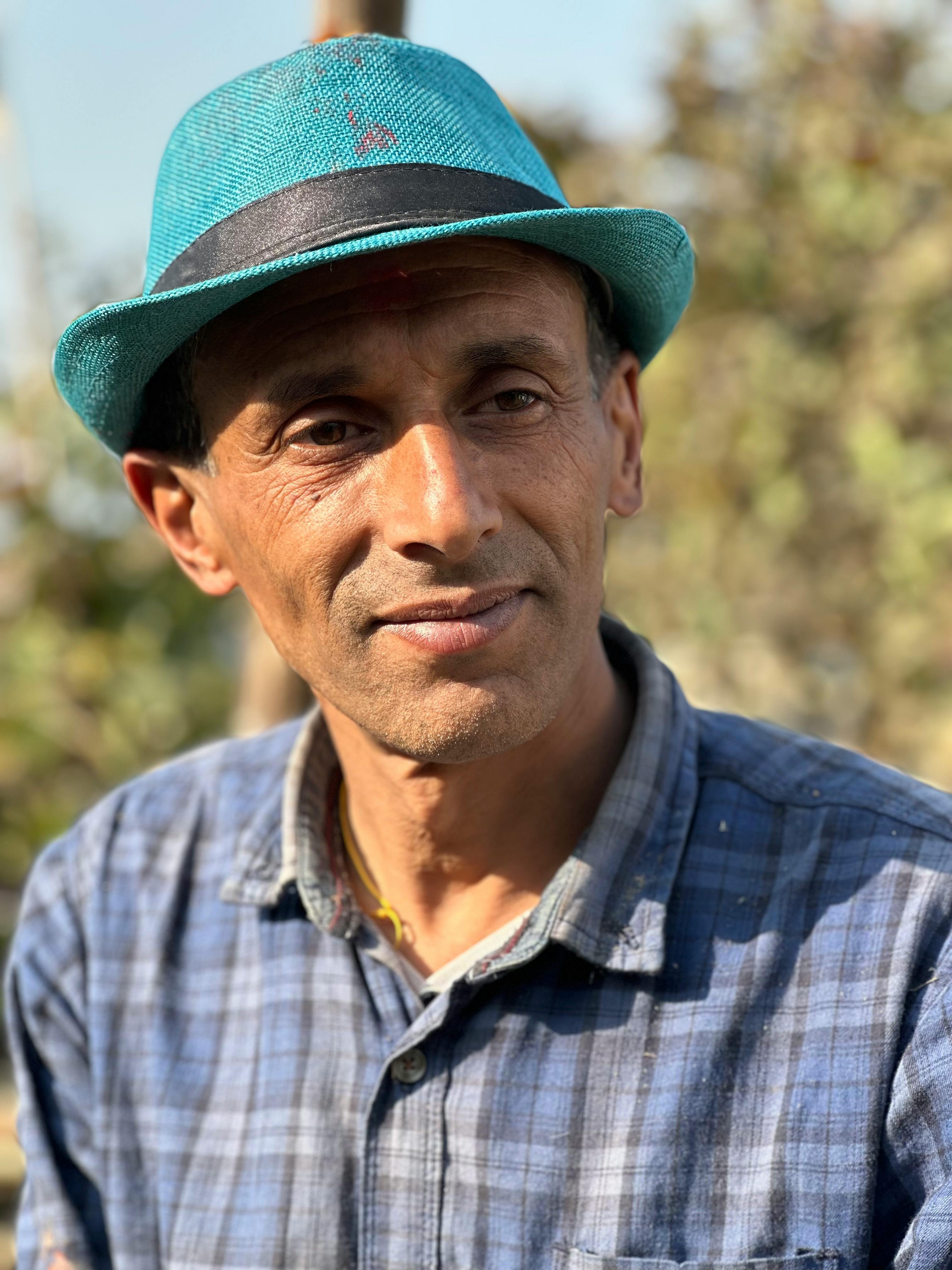 Man in a Green Hat and Checkered Shirt · Free Stock Photo