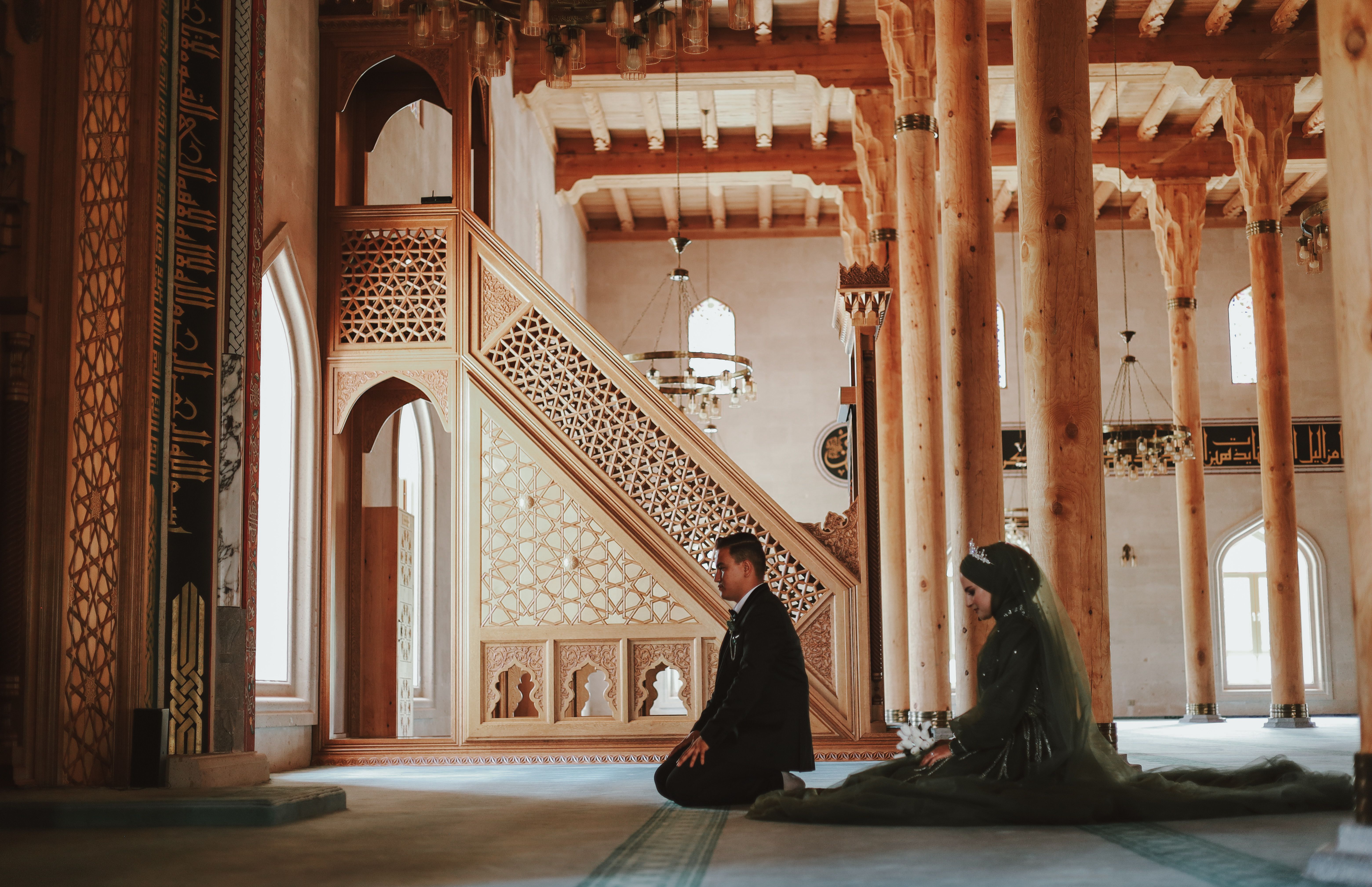 Newlywed Couple Kneeling in a Mosque · Free Stock Photo