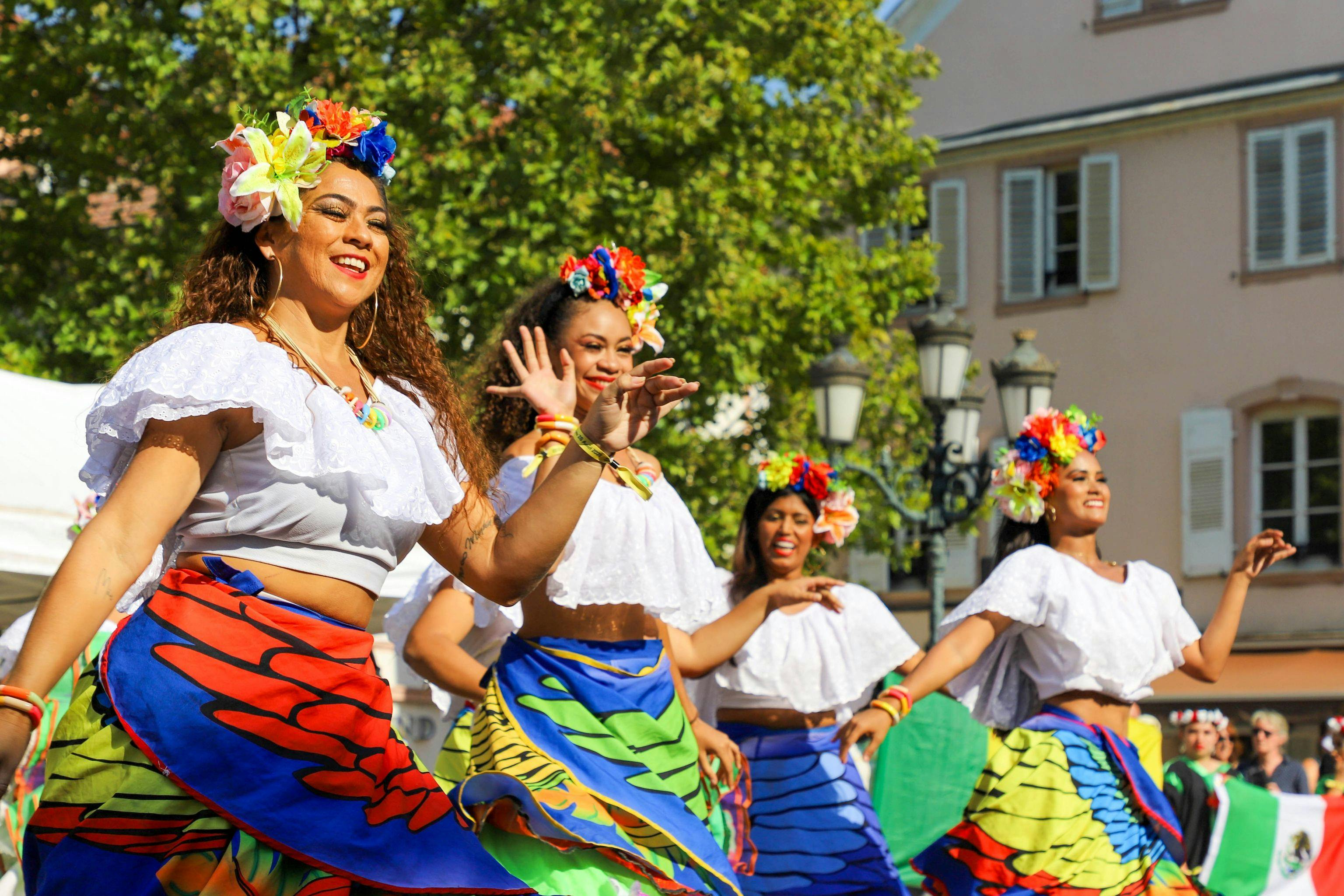Smiling Women Dancing in Traditional Clothing · Free Stock Photo
