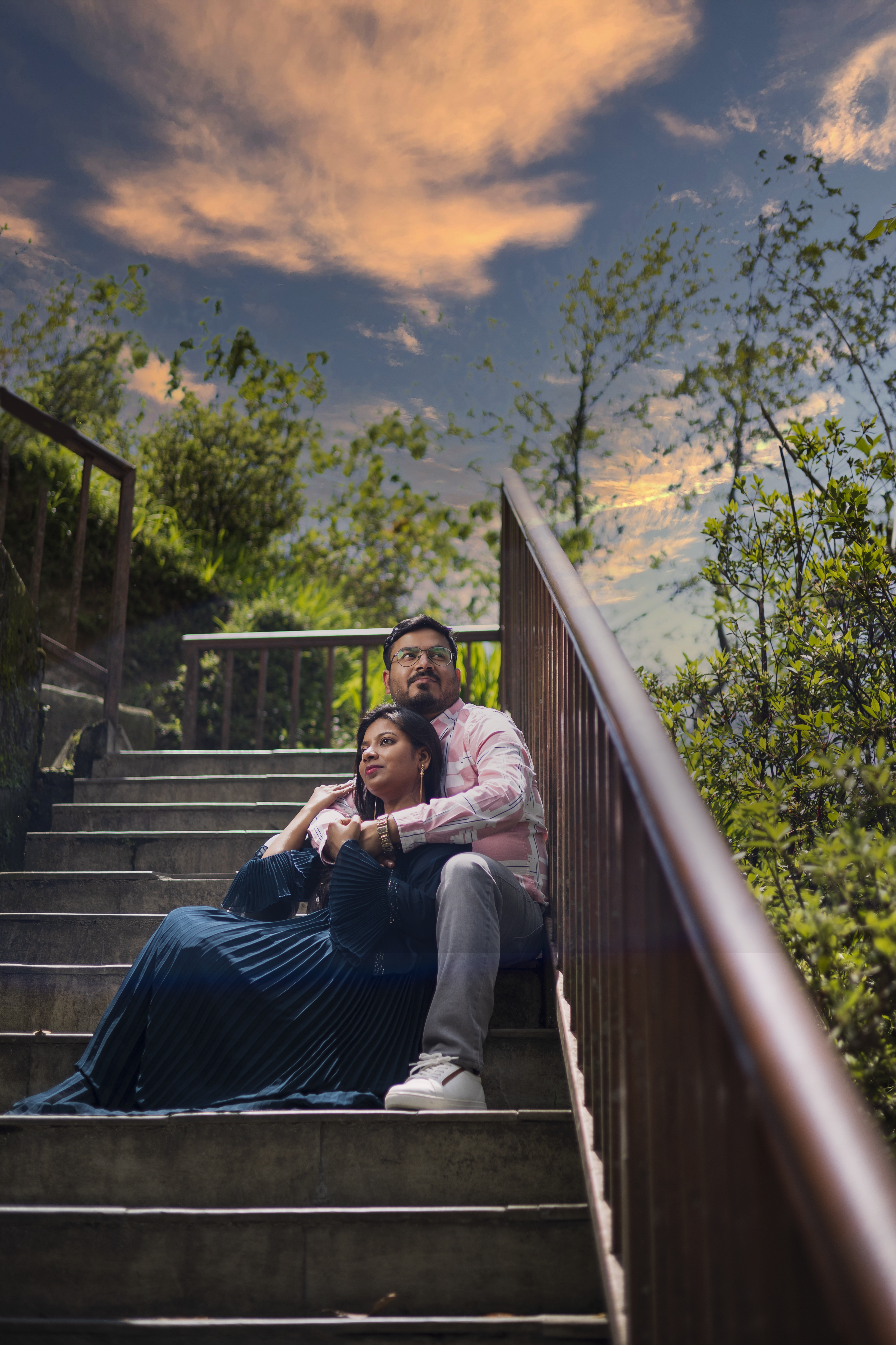 Low Angle Shot of a Couple Sitting on the Steps · Free Stock Photo