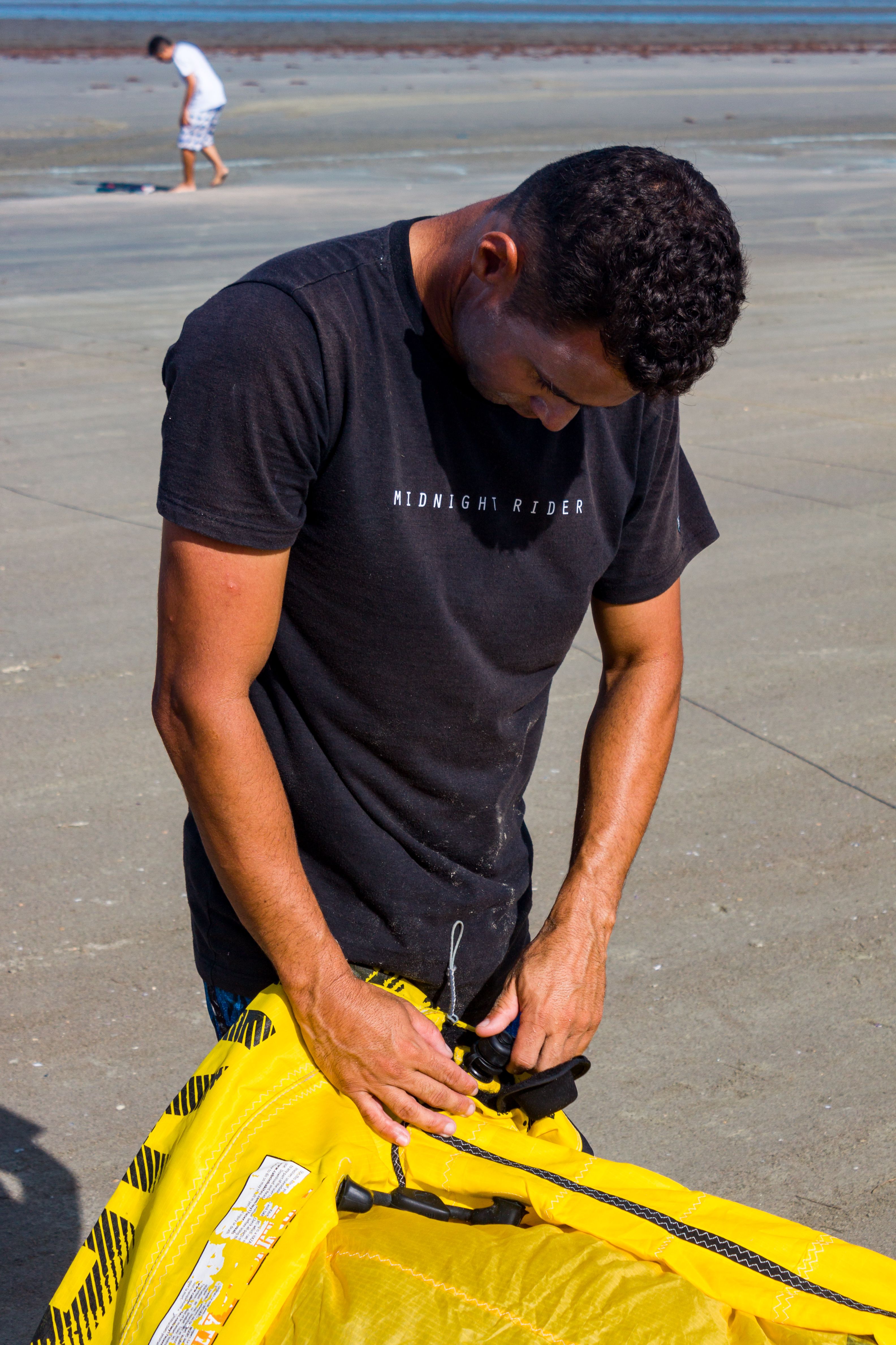 Man on the Beach Connecting the Inflatable Dinghy to the Pump · Free ...