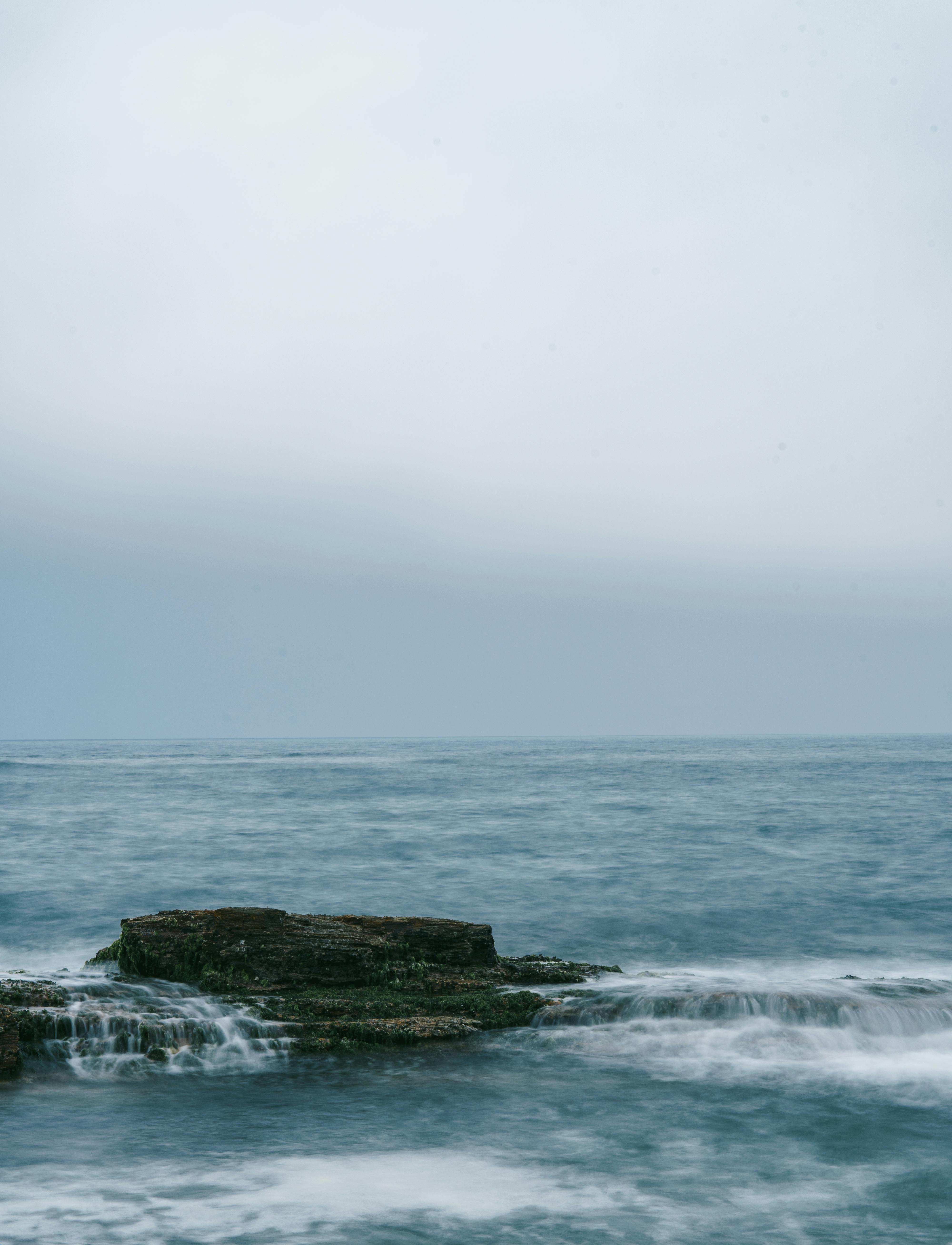 Overcast over Rocks on Sea Shore · Free Stock Photo