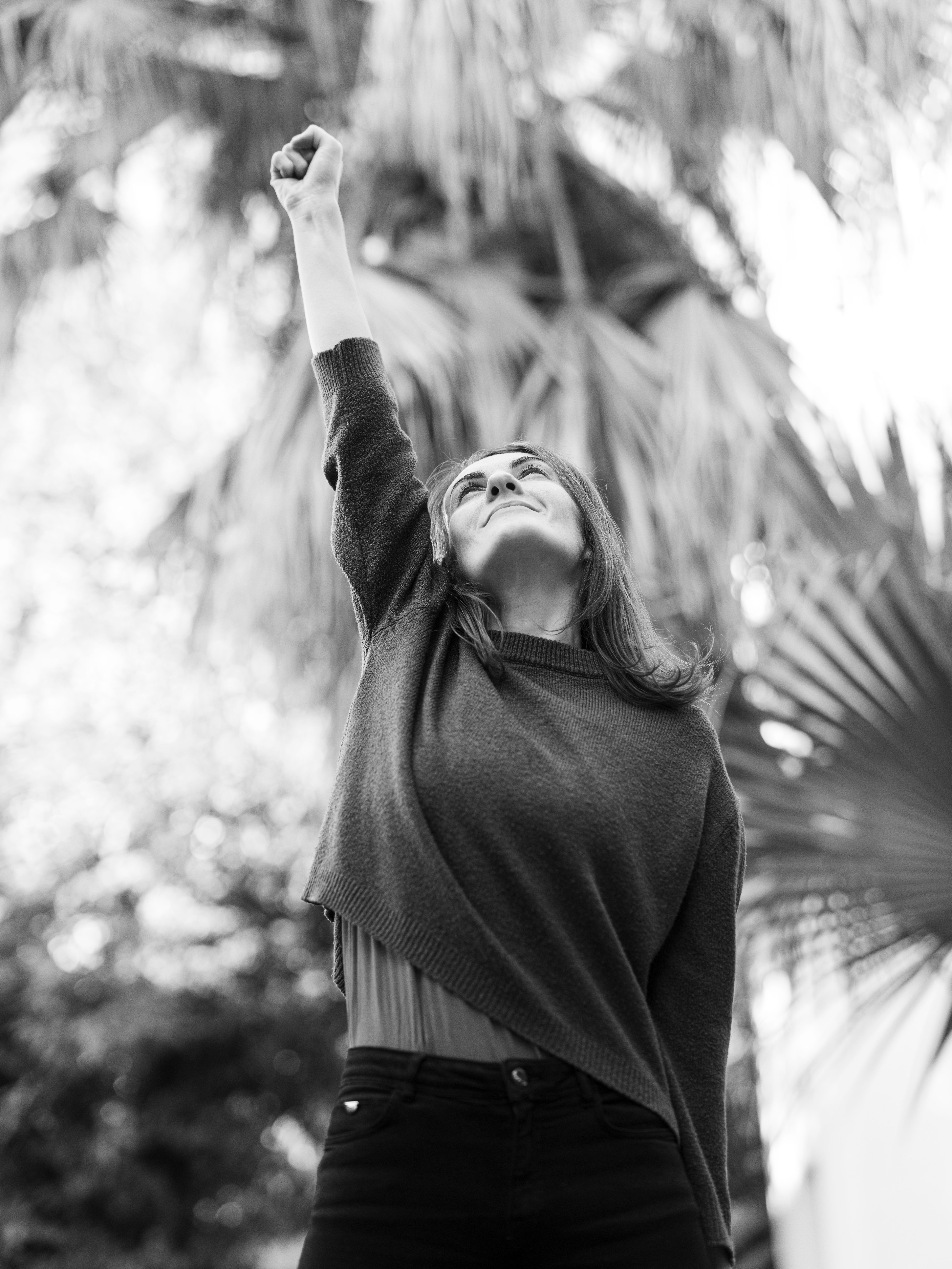 Woman in Hoodie with Raised Hand · Free Stock Photo