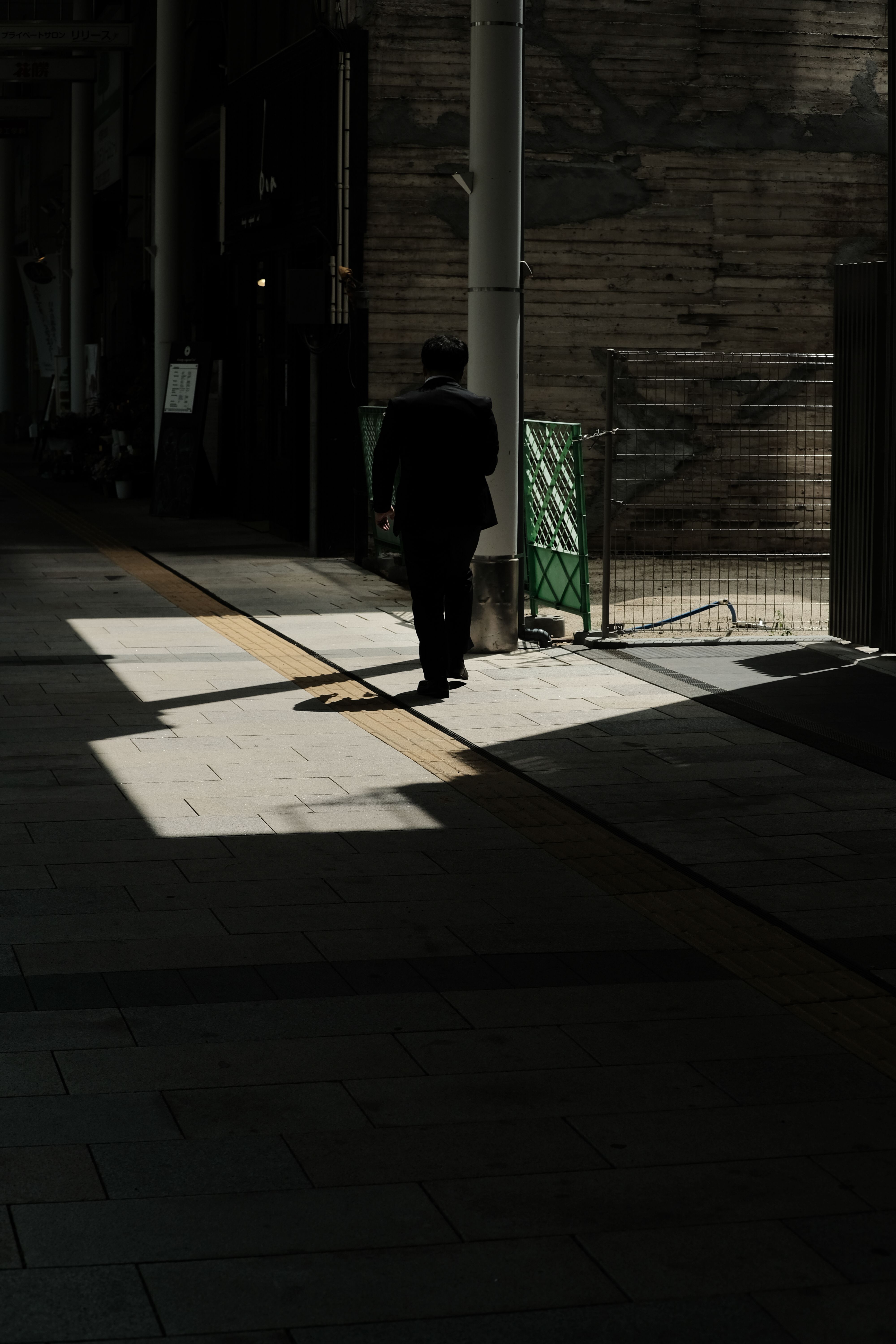 Person Walking on Pavement in Town · Free Stock Photo