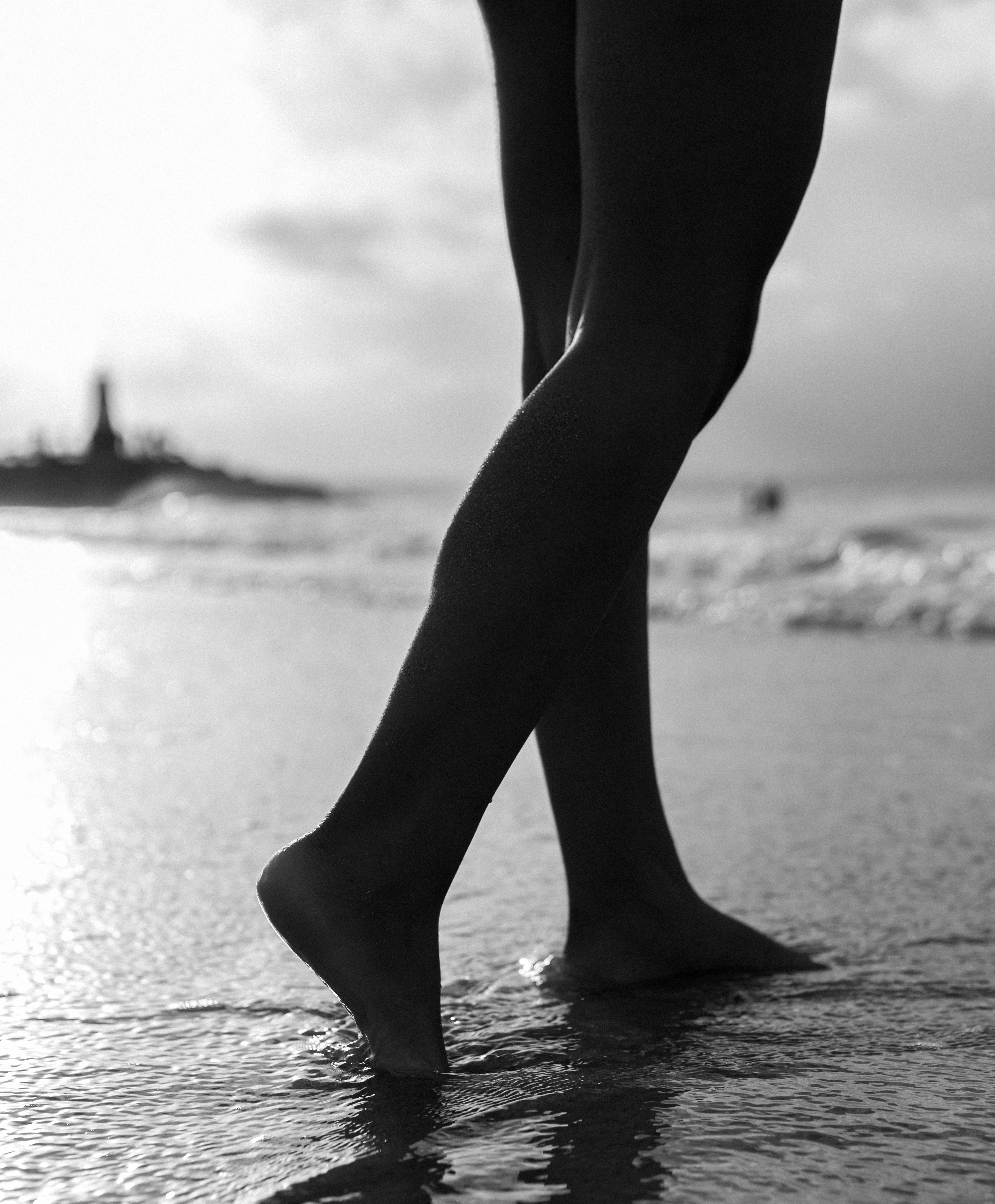 Legs of Person Standing in Water on Shore · Free Stock Photo