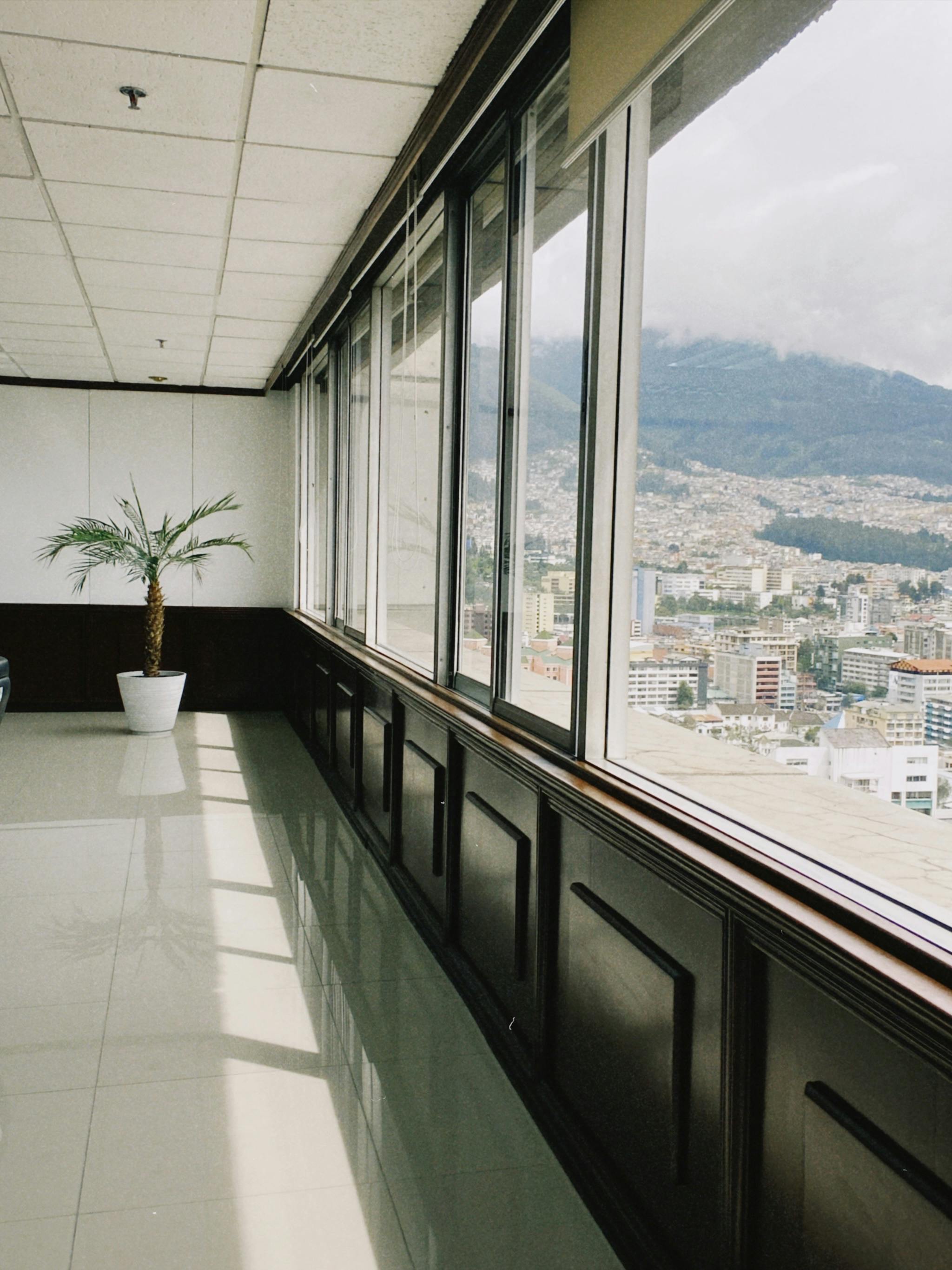A Modern Interior with a Wall of Windows with the View of the City ...