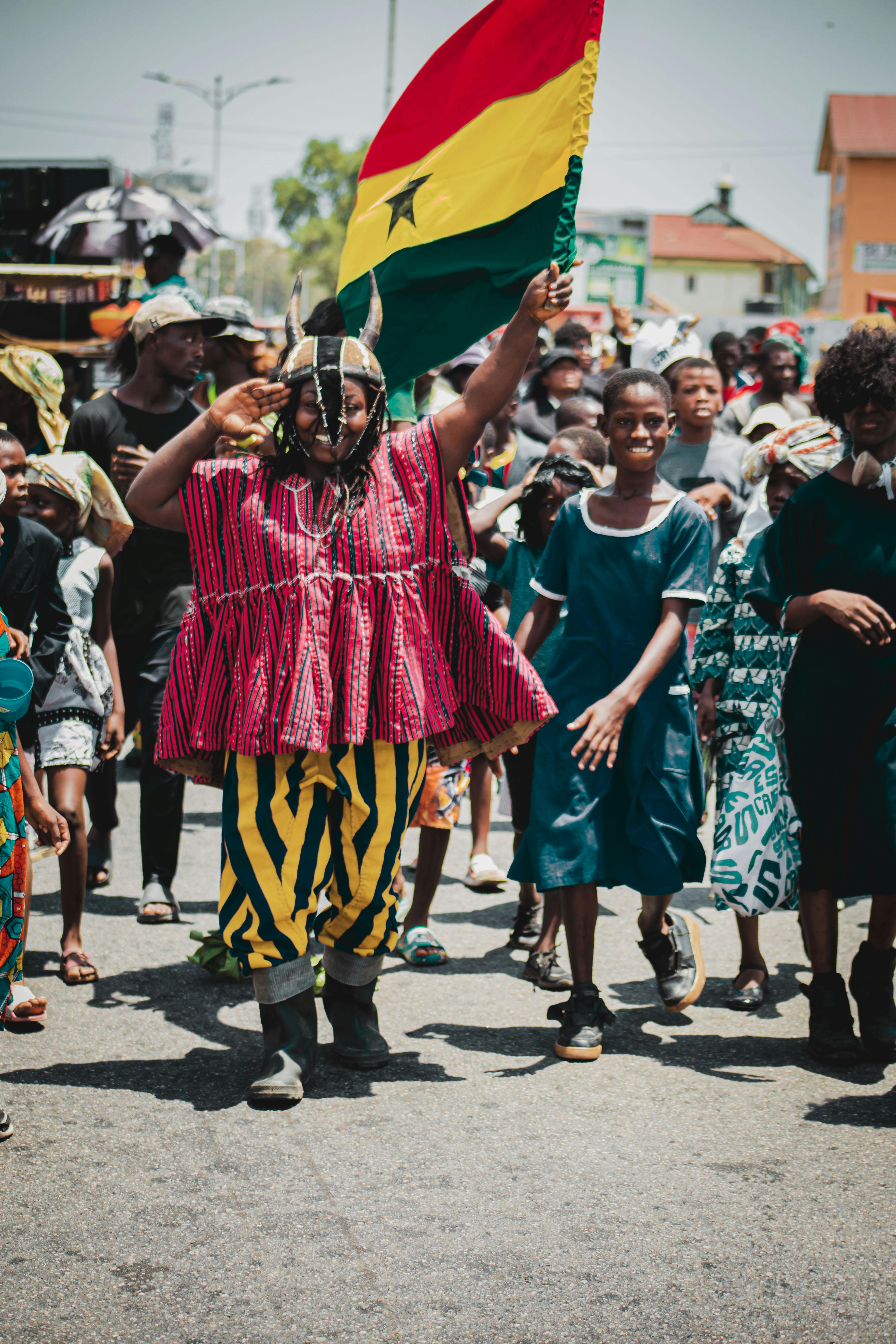 View of a Crowd Walking on a Street with a Flag of Ghana and Smiling ...