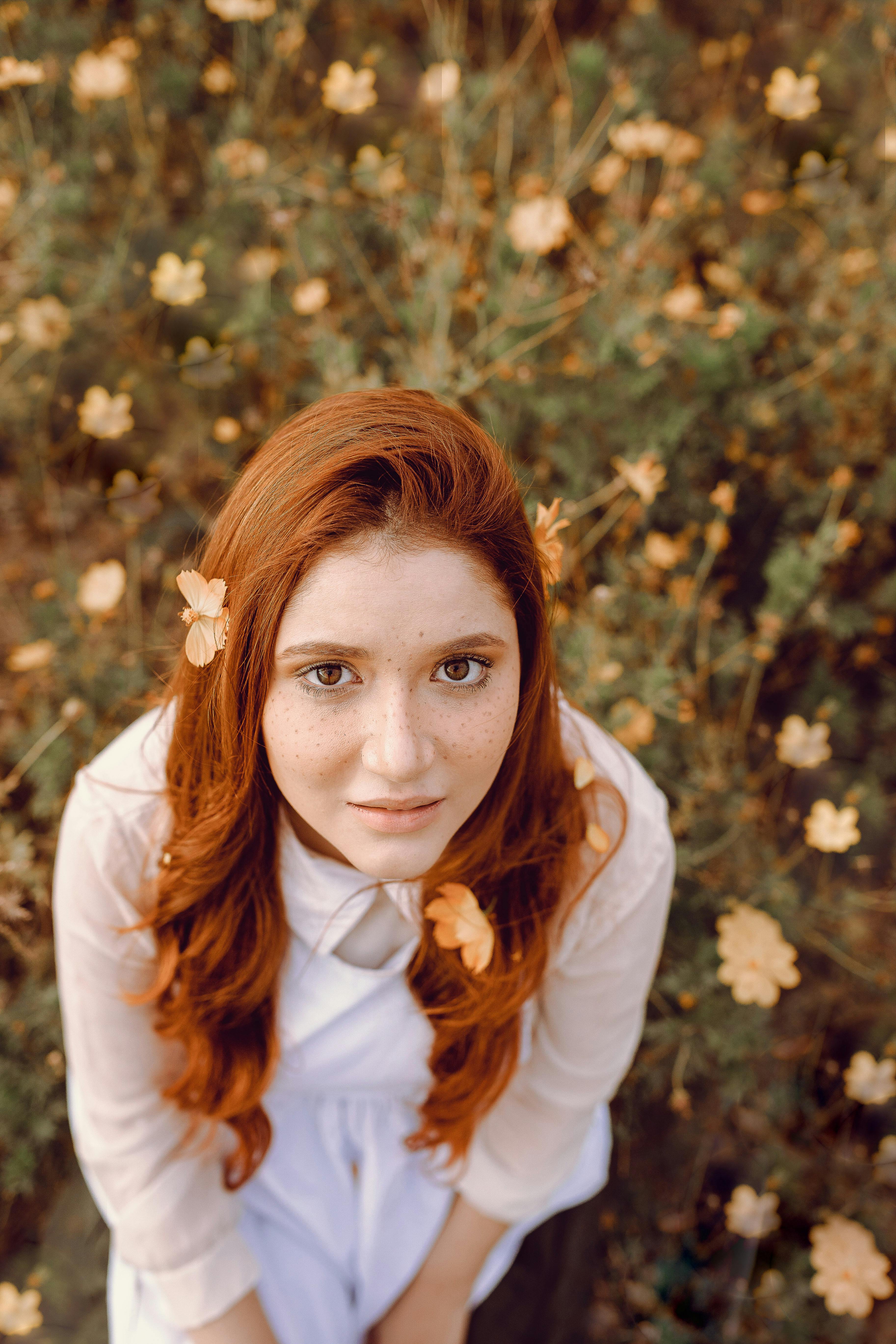 High Angle View of a Redhead Girl in Meadow with Yellow Flowers · Free ...