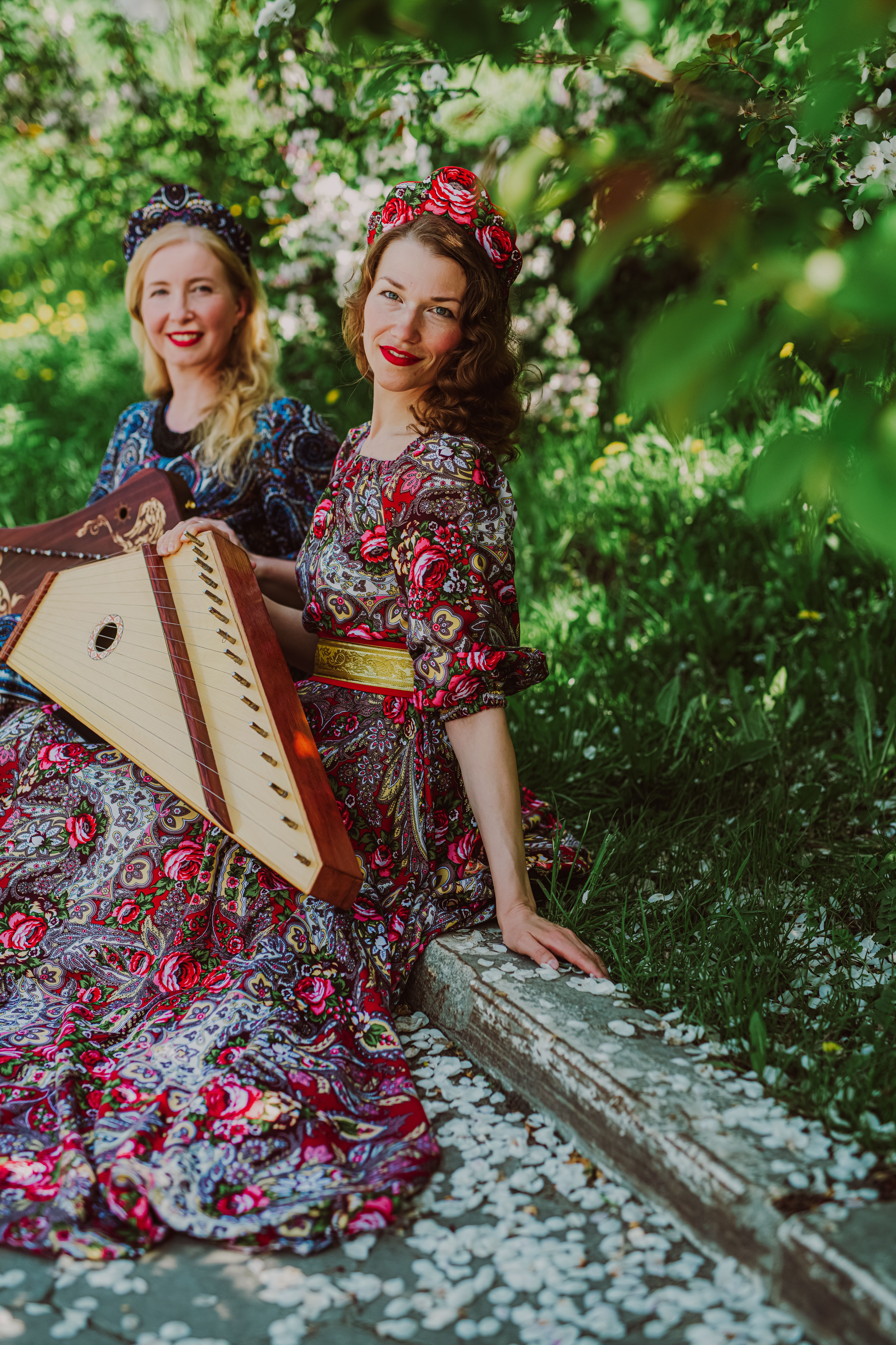 Women in Traditional Dresses Sitting with Traditional Music Instrument ...