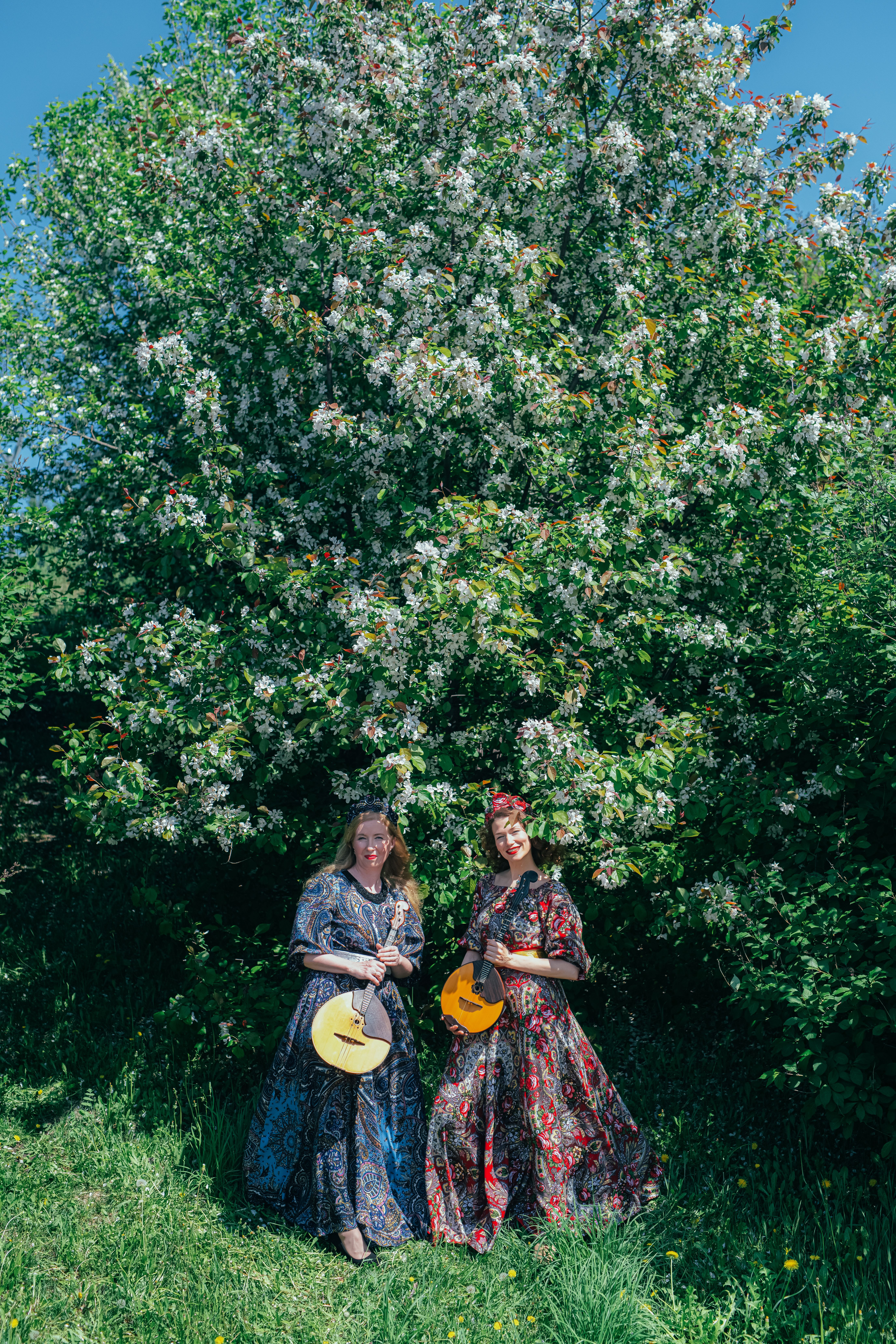 Women in Traditional Clothing and with Traditional Instruments Posing ...