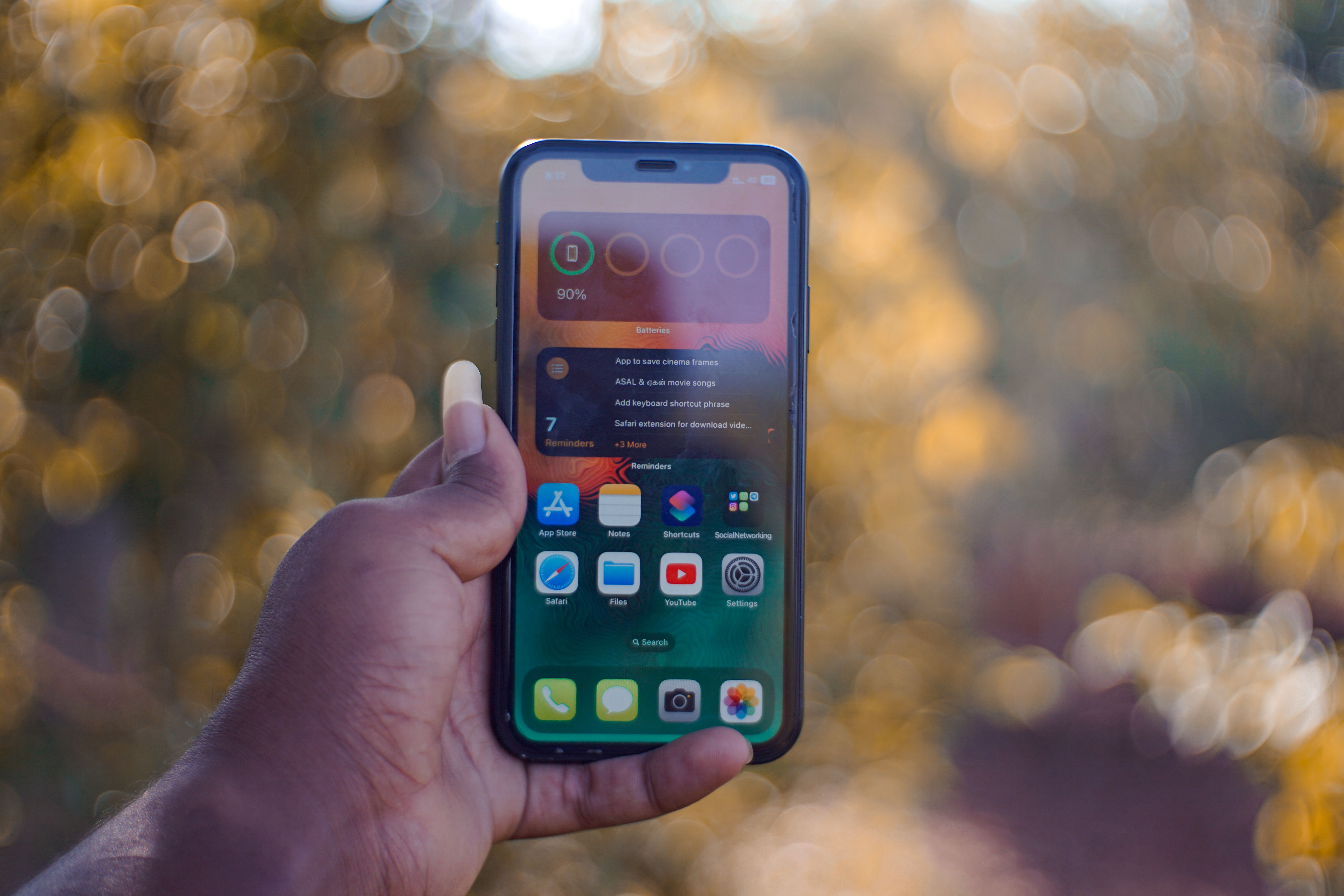 Hand Holding Smartphone with Model with Leaf on it · Free Stock Photo