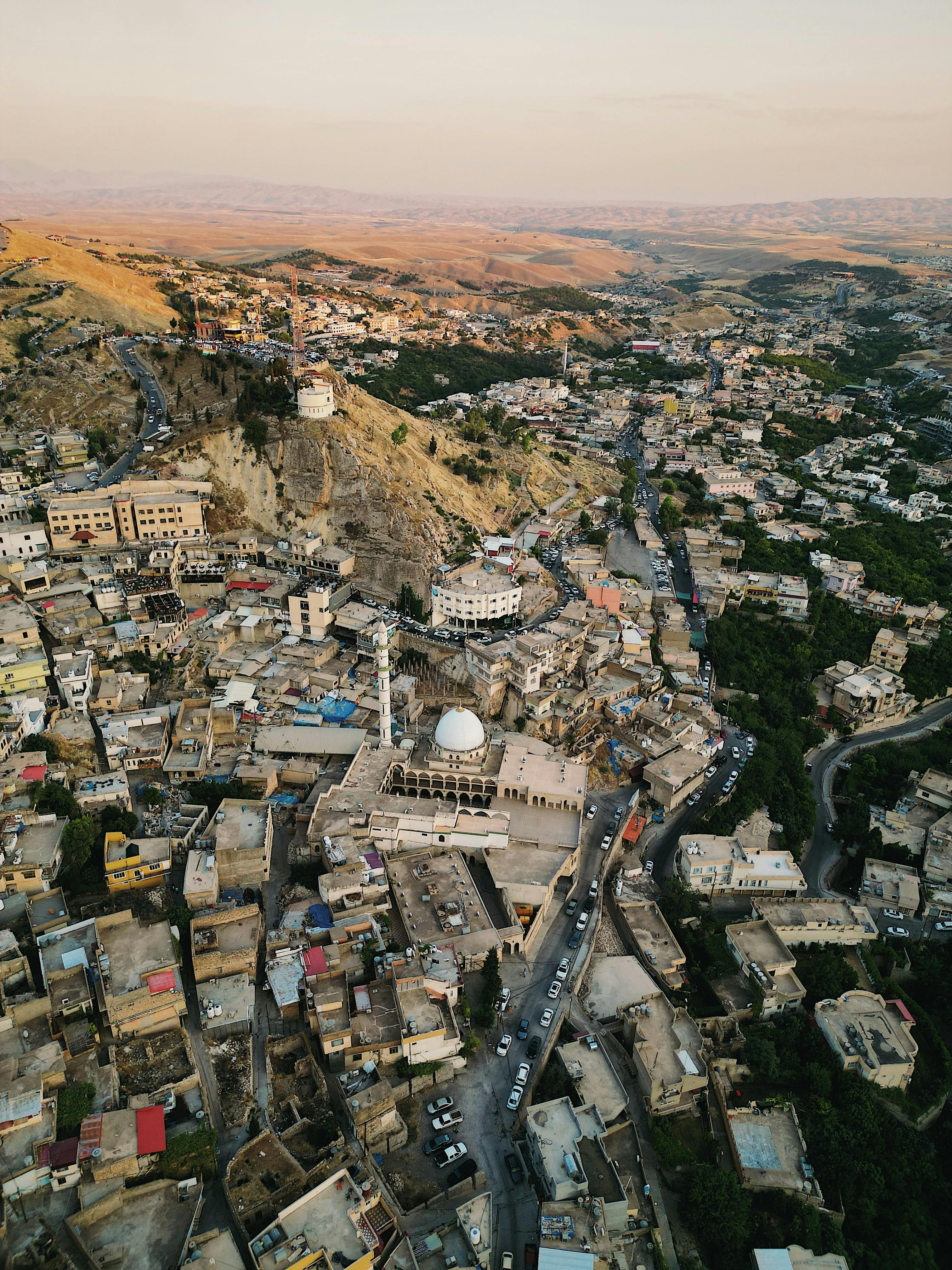 Aerial View of a Town and Sandstone Hills in the Horizon · Free Stock Photo
