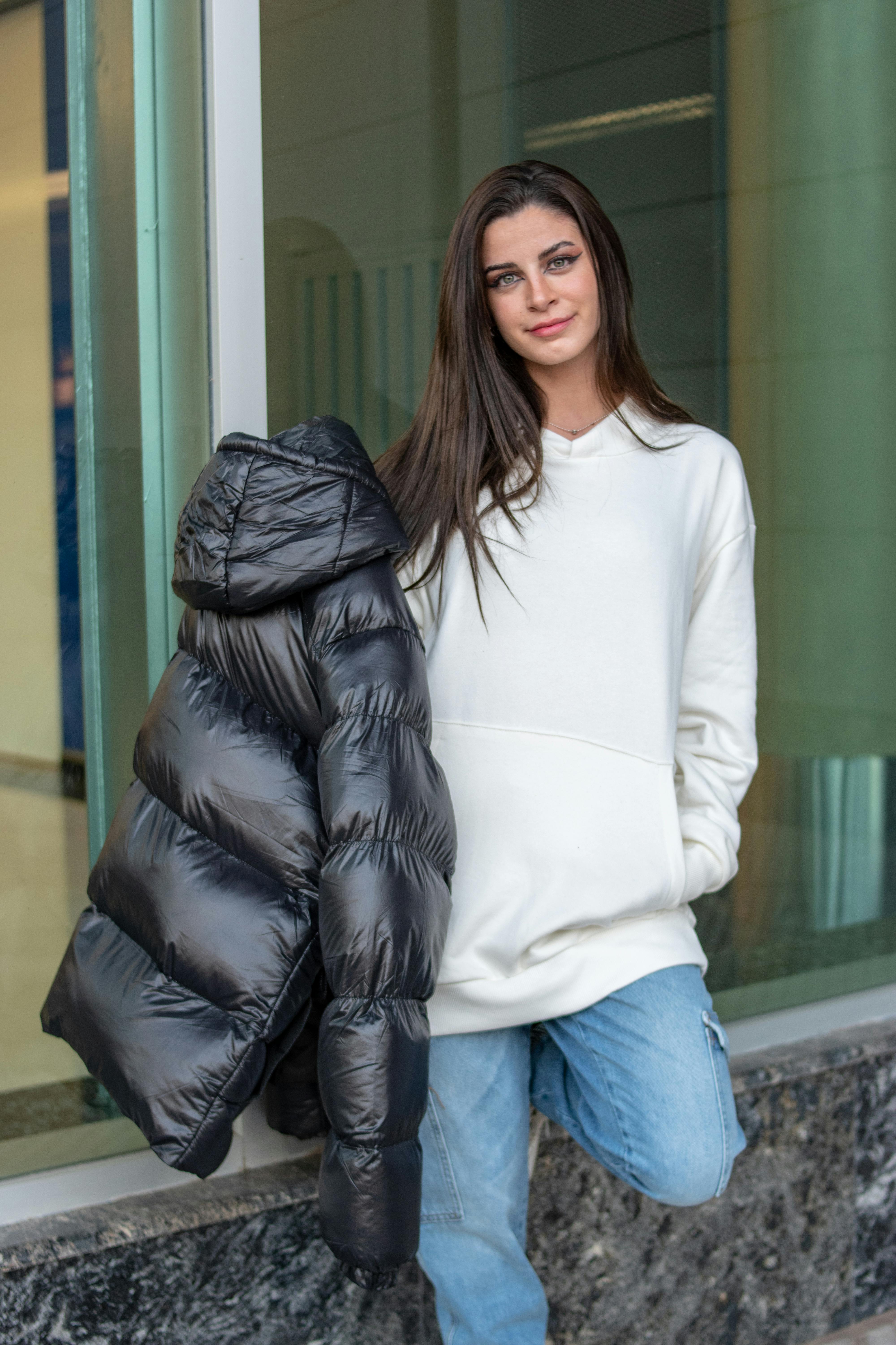 Woman Wearing A Black Jacket Standing Standing In Front Of A Metal ...