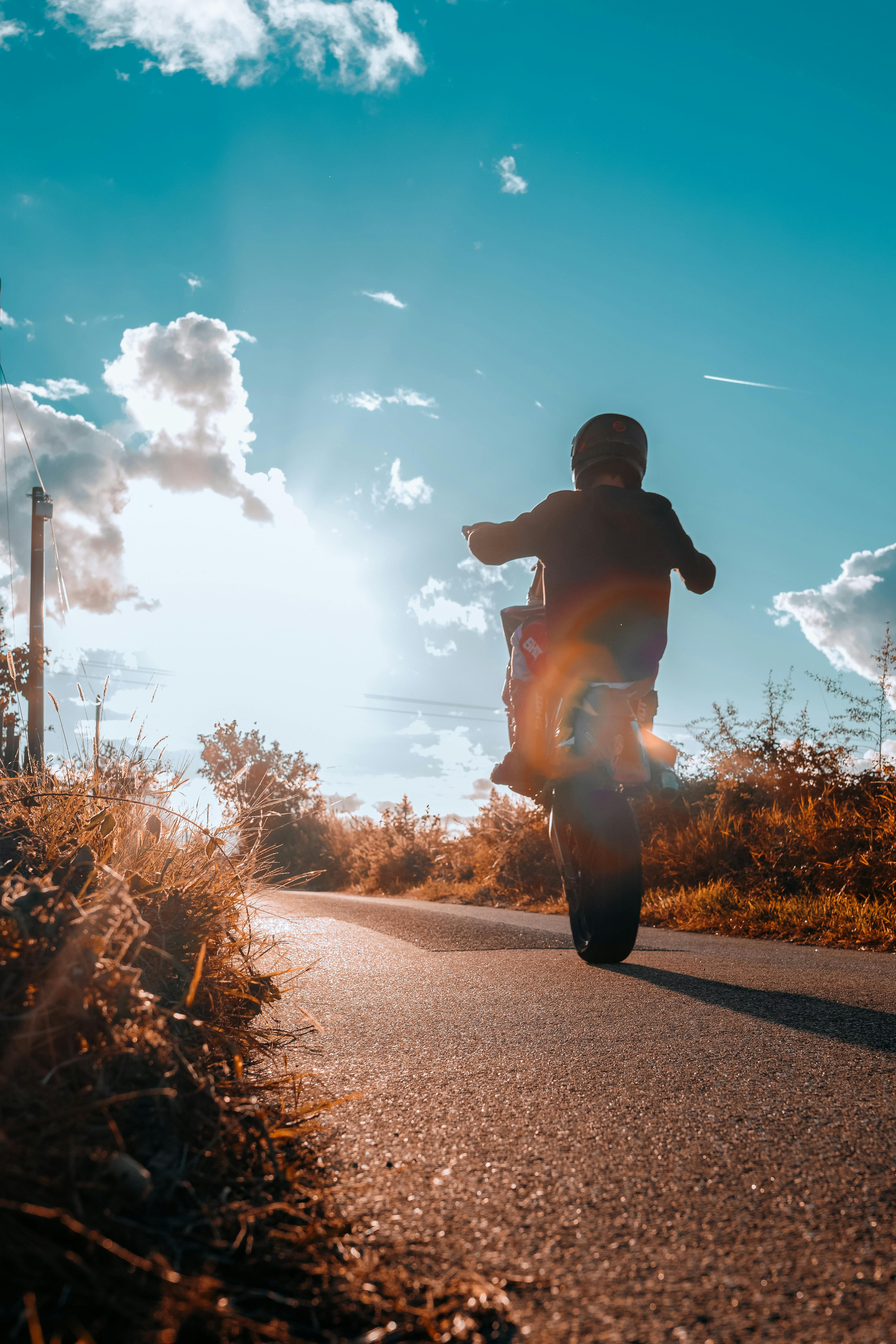 Biker Making a Wheelie on Motorcycle · Free Stock Photo