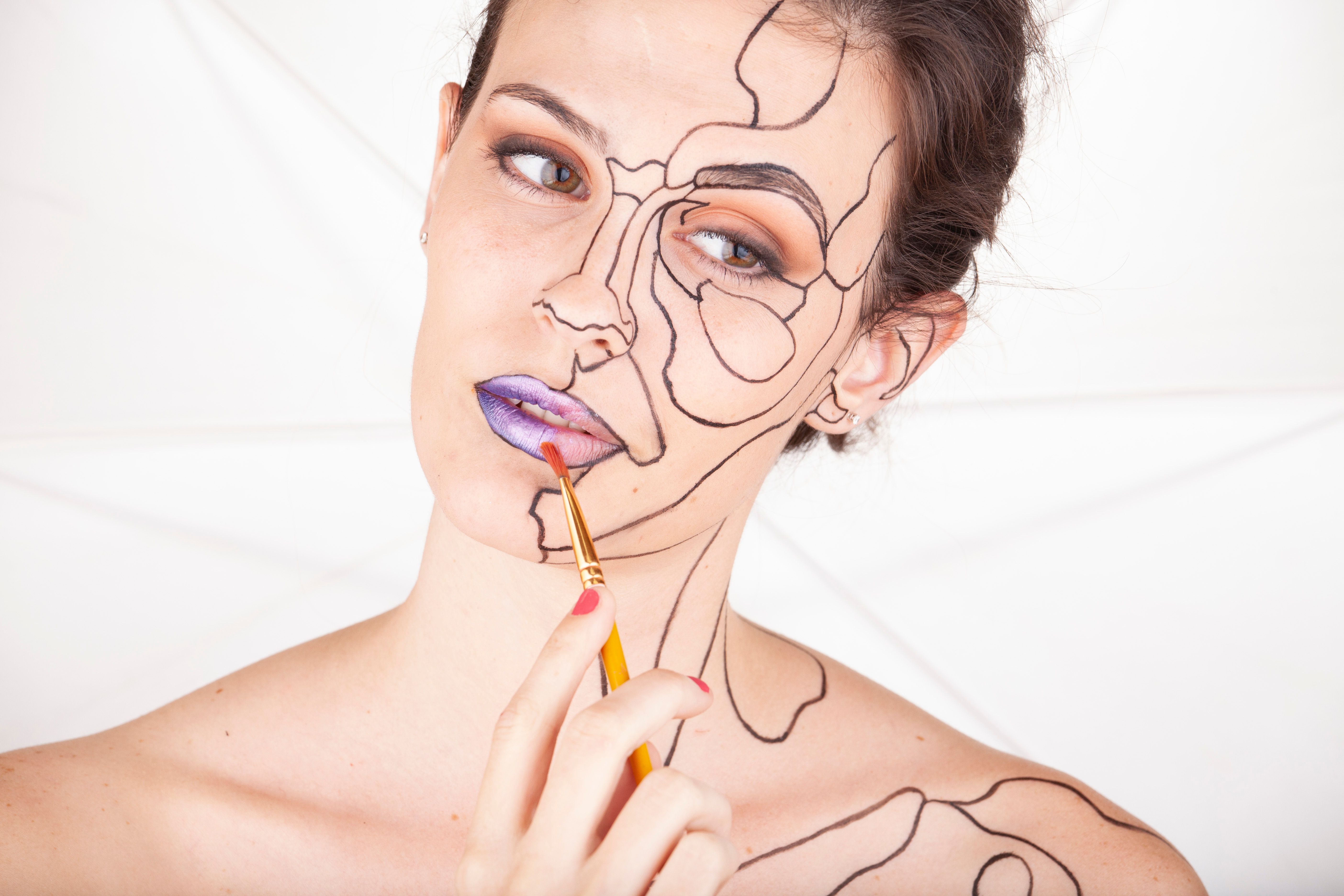 Young Brunette Woman with Face Paint on her Forehead · Free Stock Photo