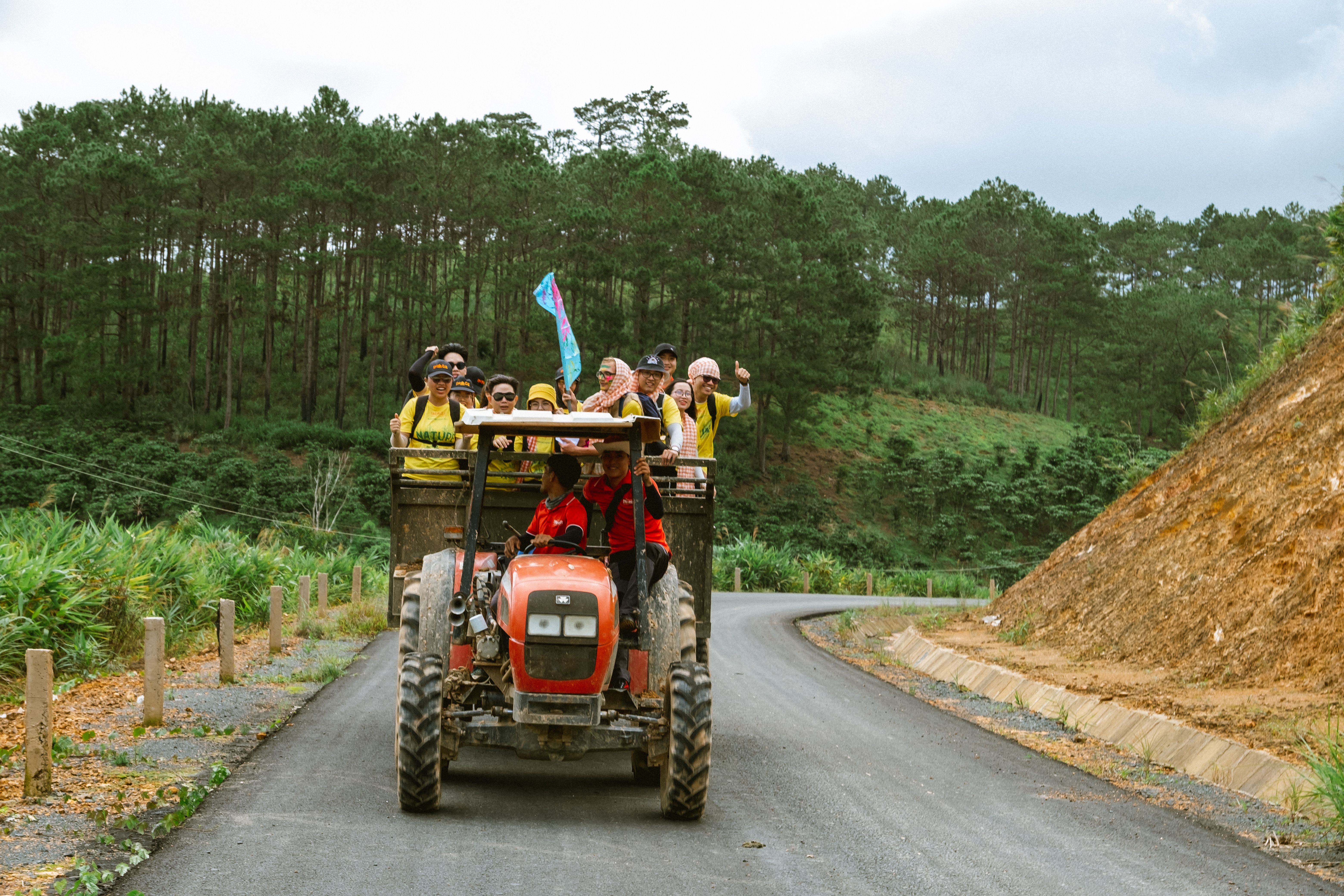 People on Tractor Trailer on Road · Free Stock Photo