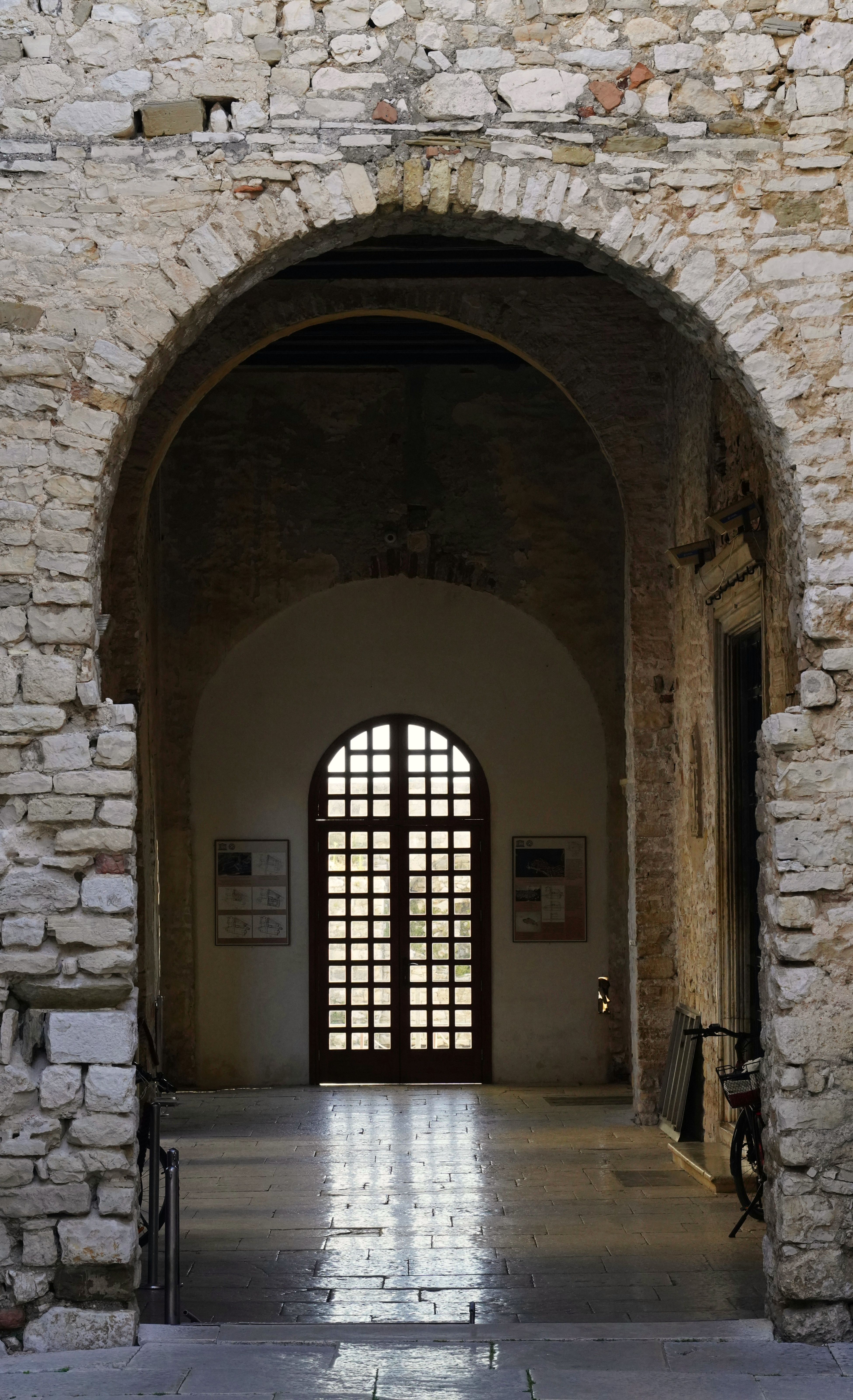 Corridor under Stone Arch · Free Stock Photo