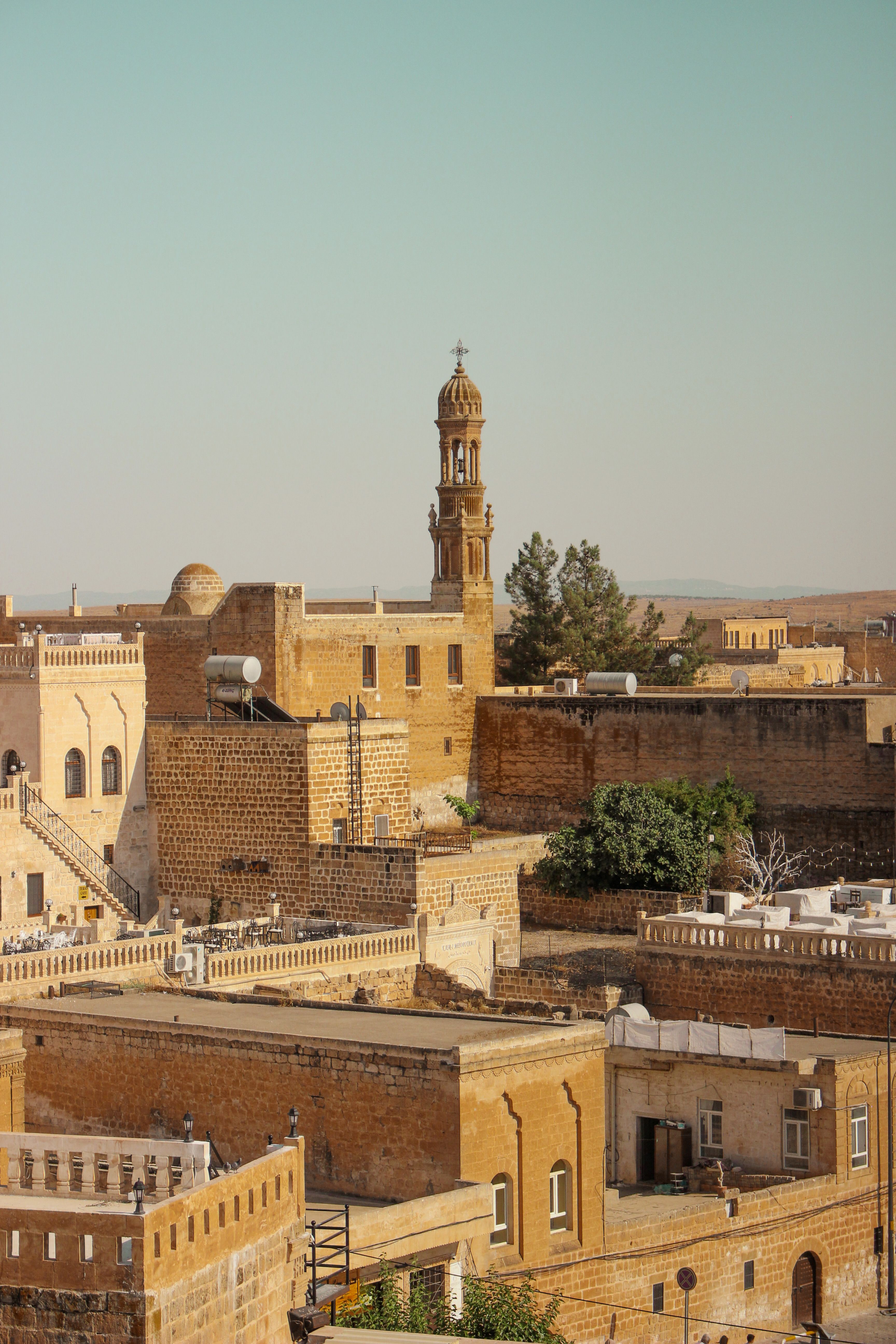Church Tower behind Buildings in Midyat in Turkey · Free Stock Photo
