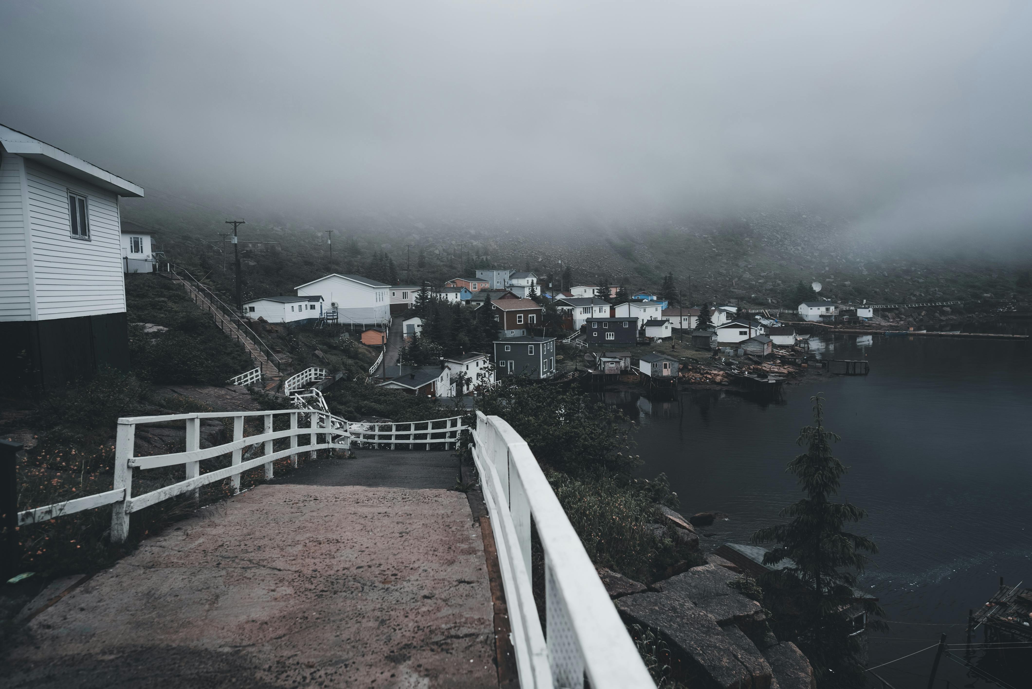 Thick Fog Gathering over a Small Coastal Village · Free Stock Photo