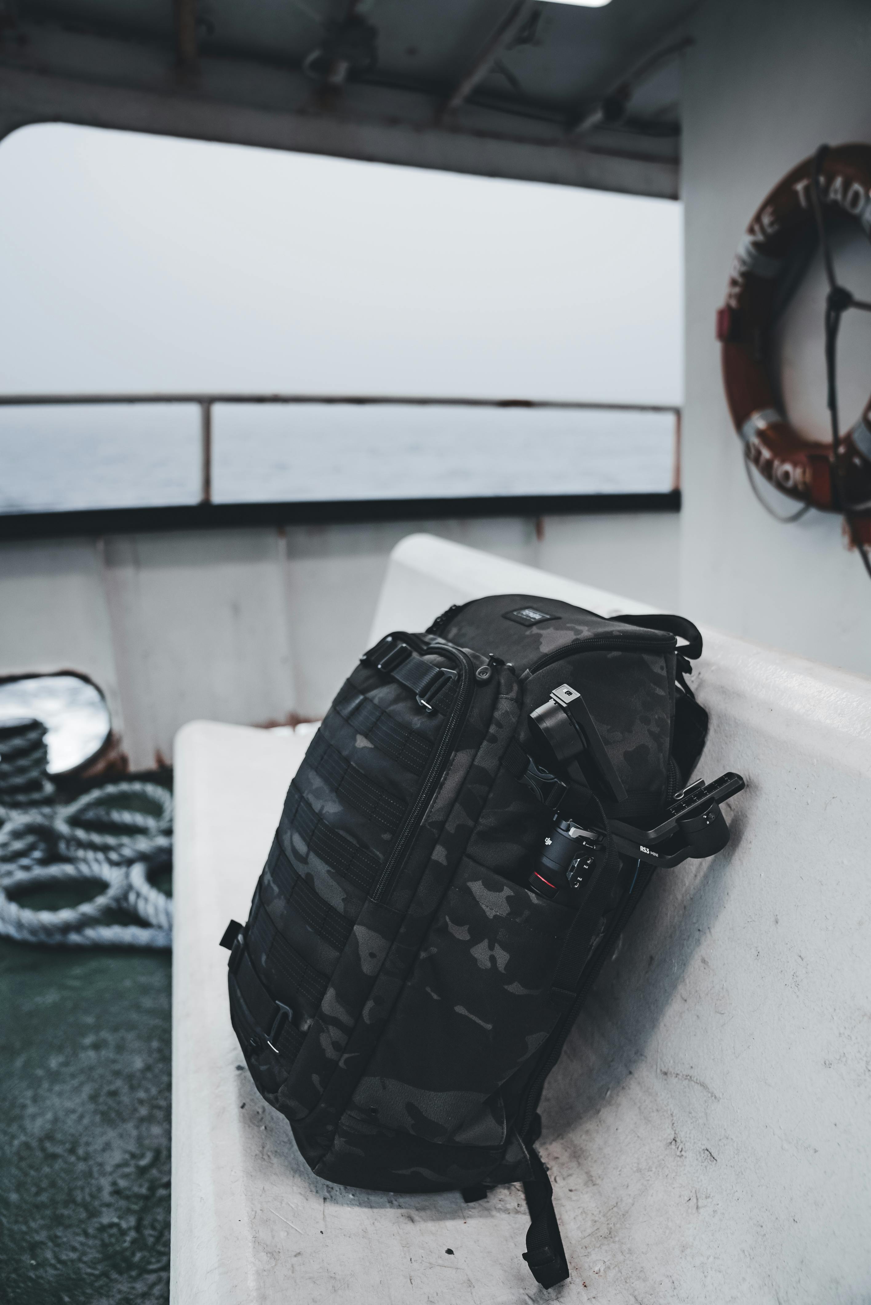Backpack Lying at bottom of Metal Steps on a Boat · Free Stock Photo