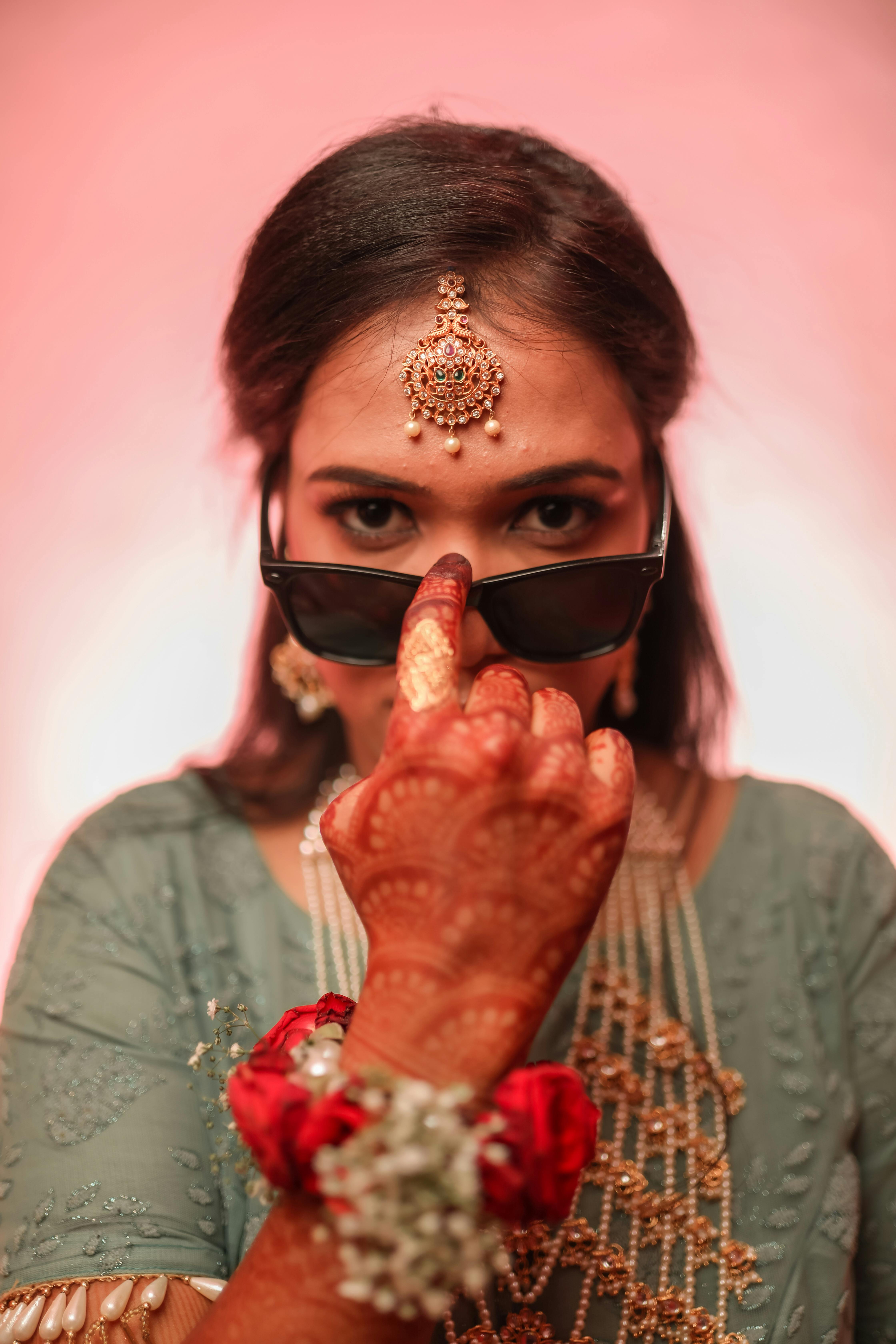 Crop Indian bride in traditional sari with henna on hands · Free Stock ...