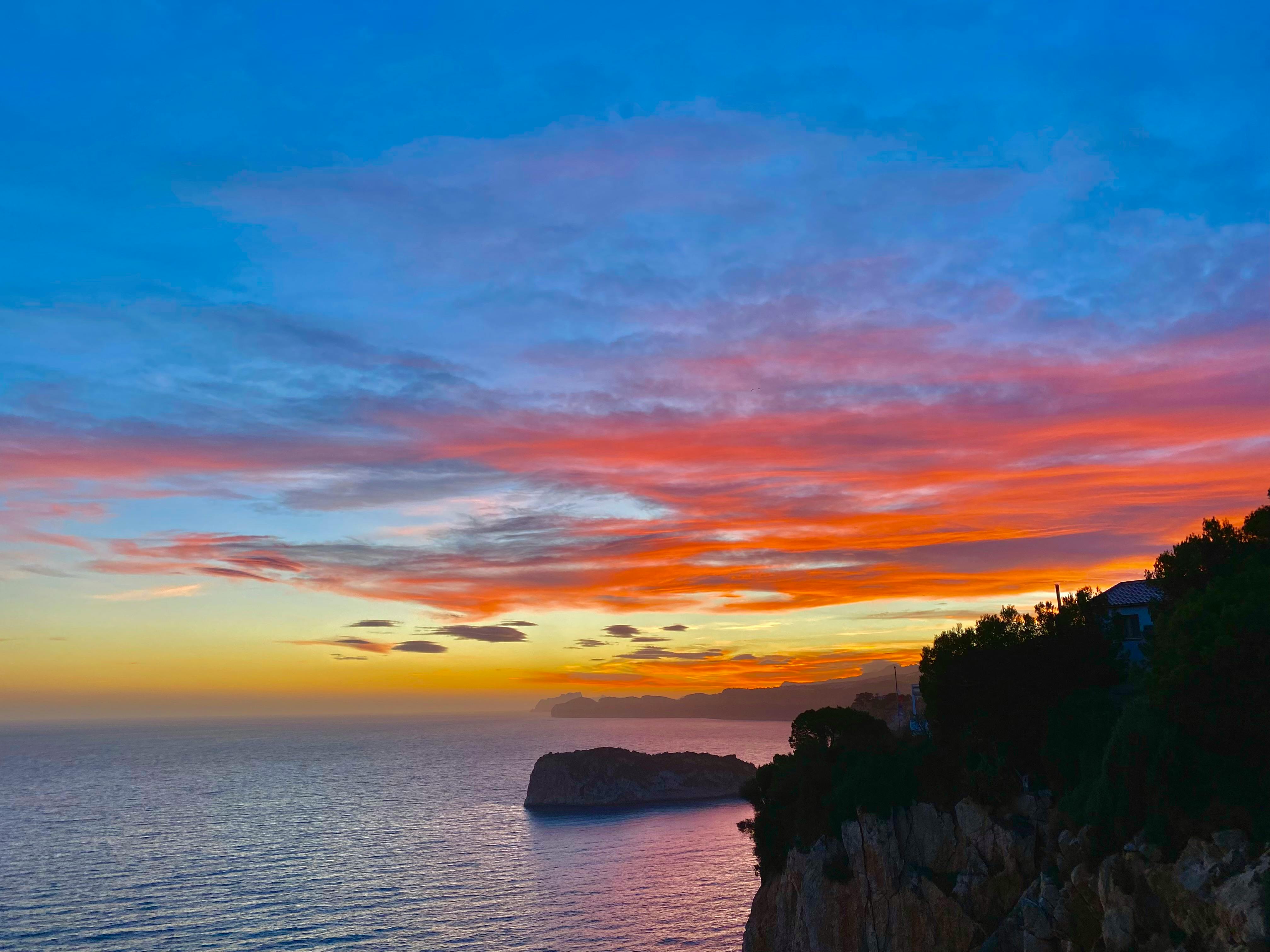 A Dramatic Sunset Sky over Cliffs and Sea · Free Stock Photo