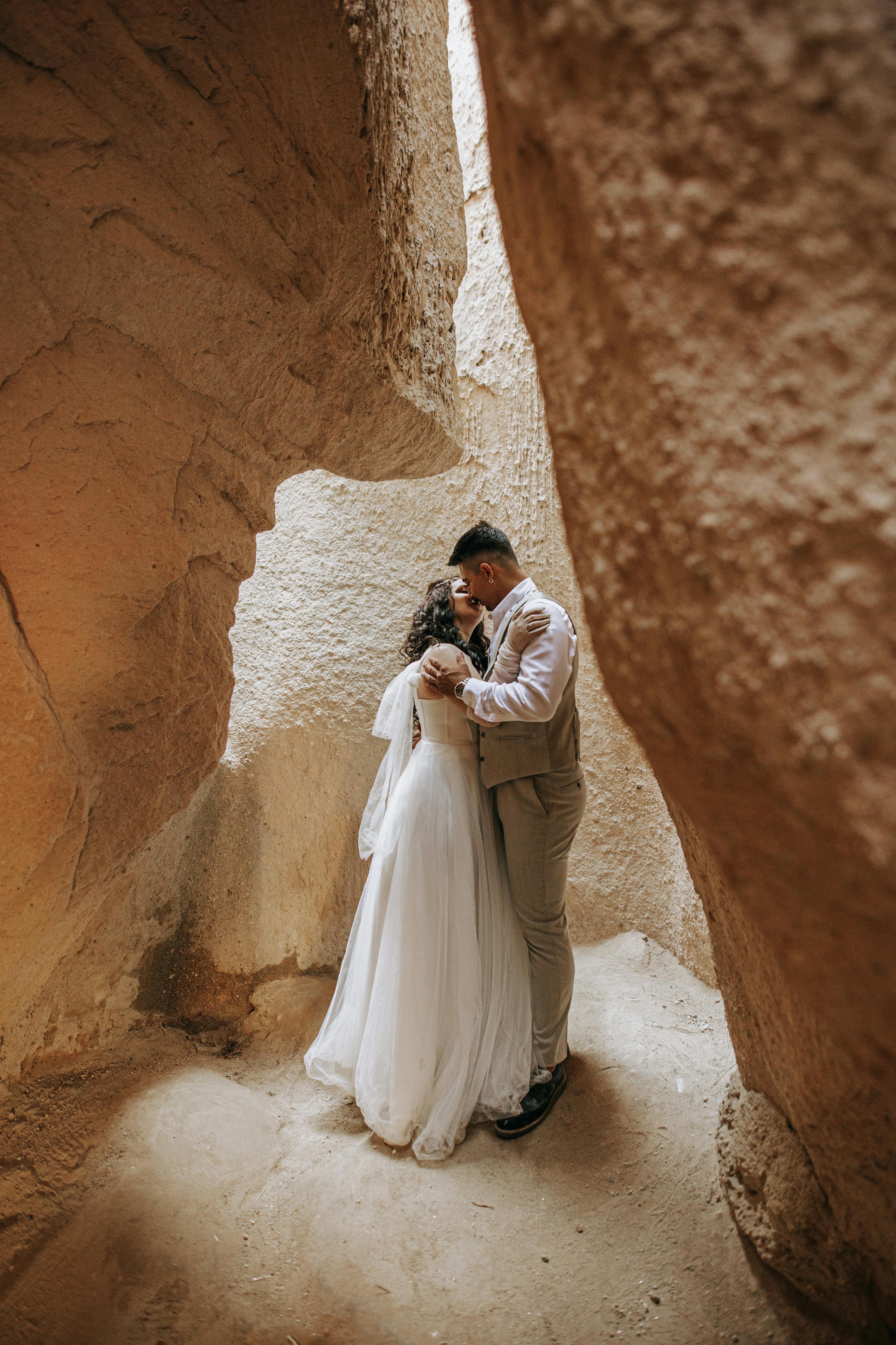 Newlywed Couple Kissing in a Cave · Free Stock Photo
