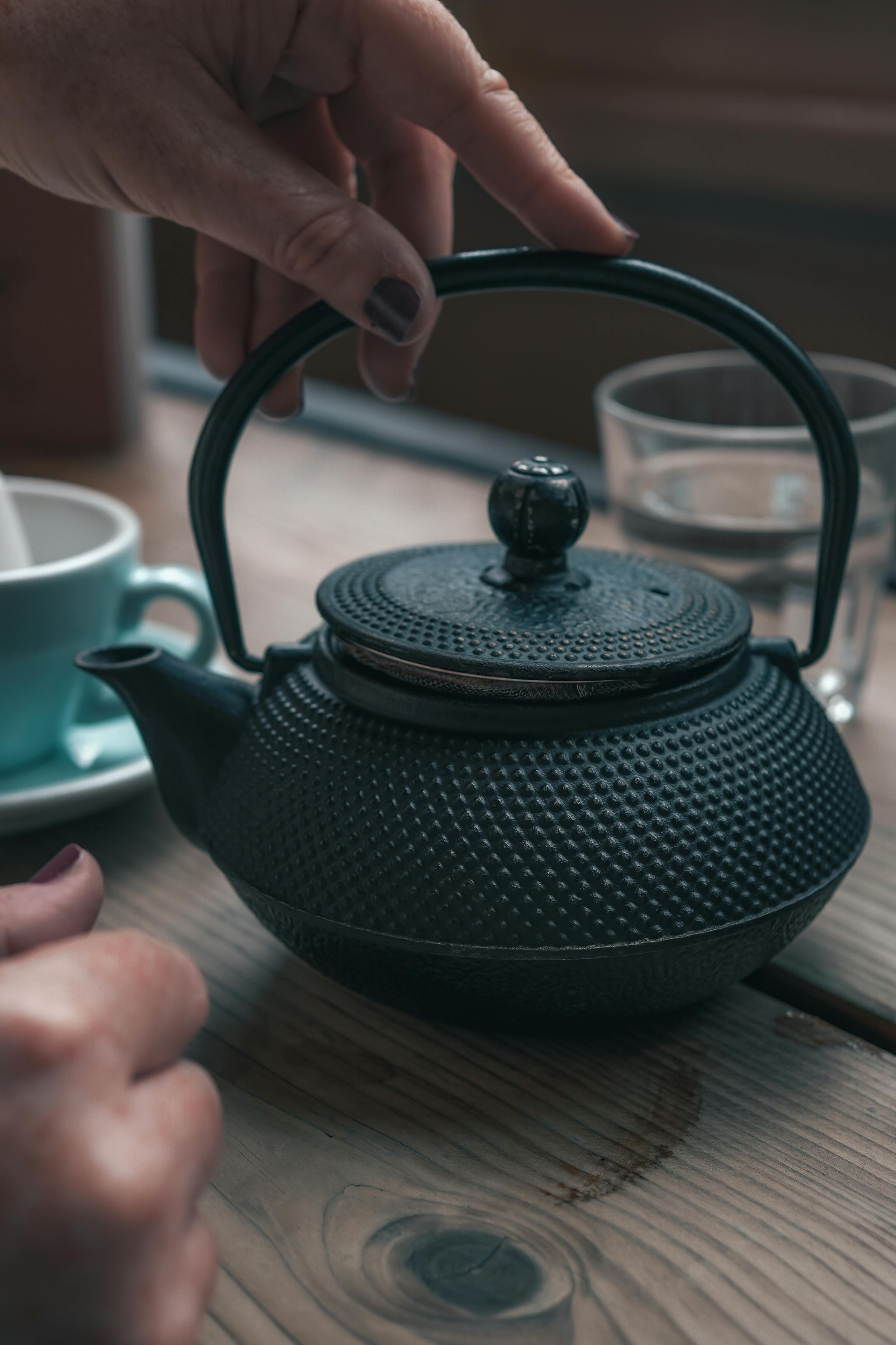 Woman Using a Kettle to Make a Tea · Free Stock Photo