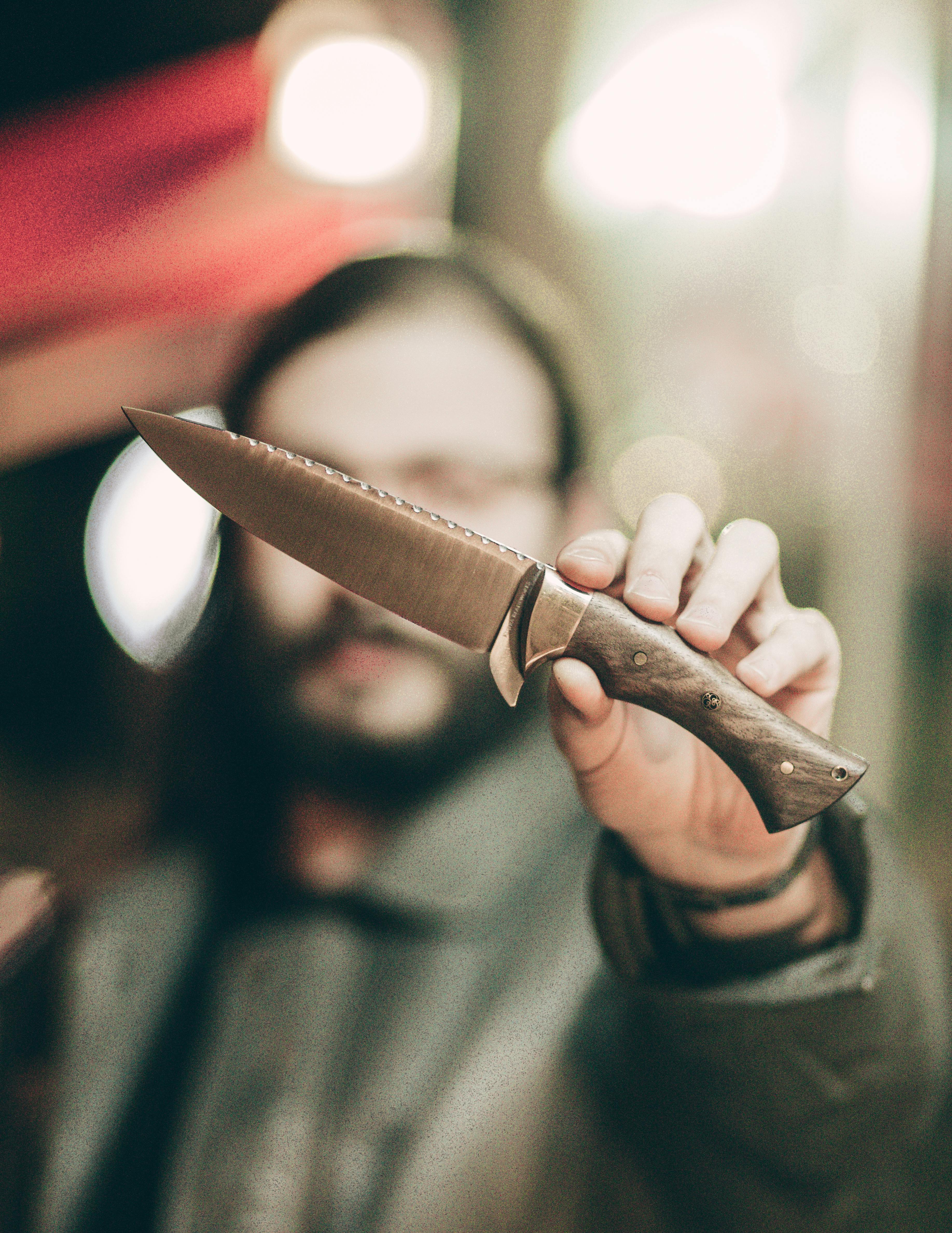 Man Holding a Knife on a Street · Free Stock Photo