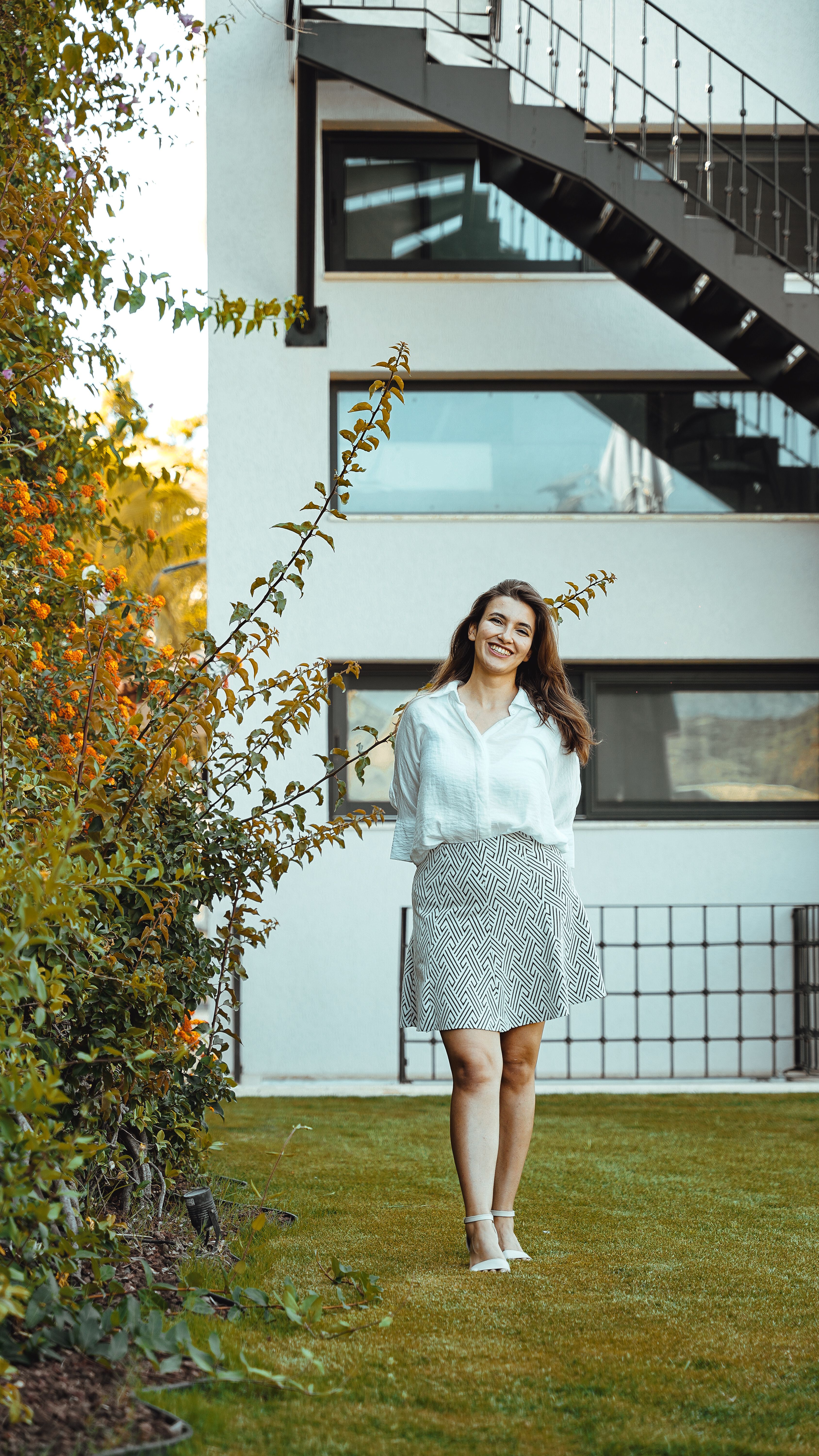 Woman Standing in Front of a Modern Building · Free Stock Photo