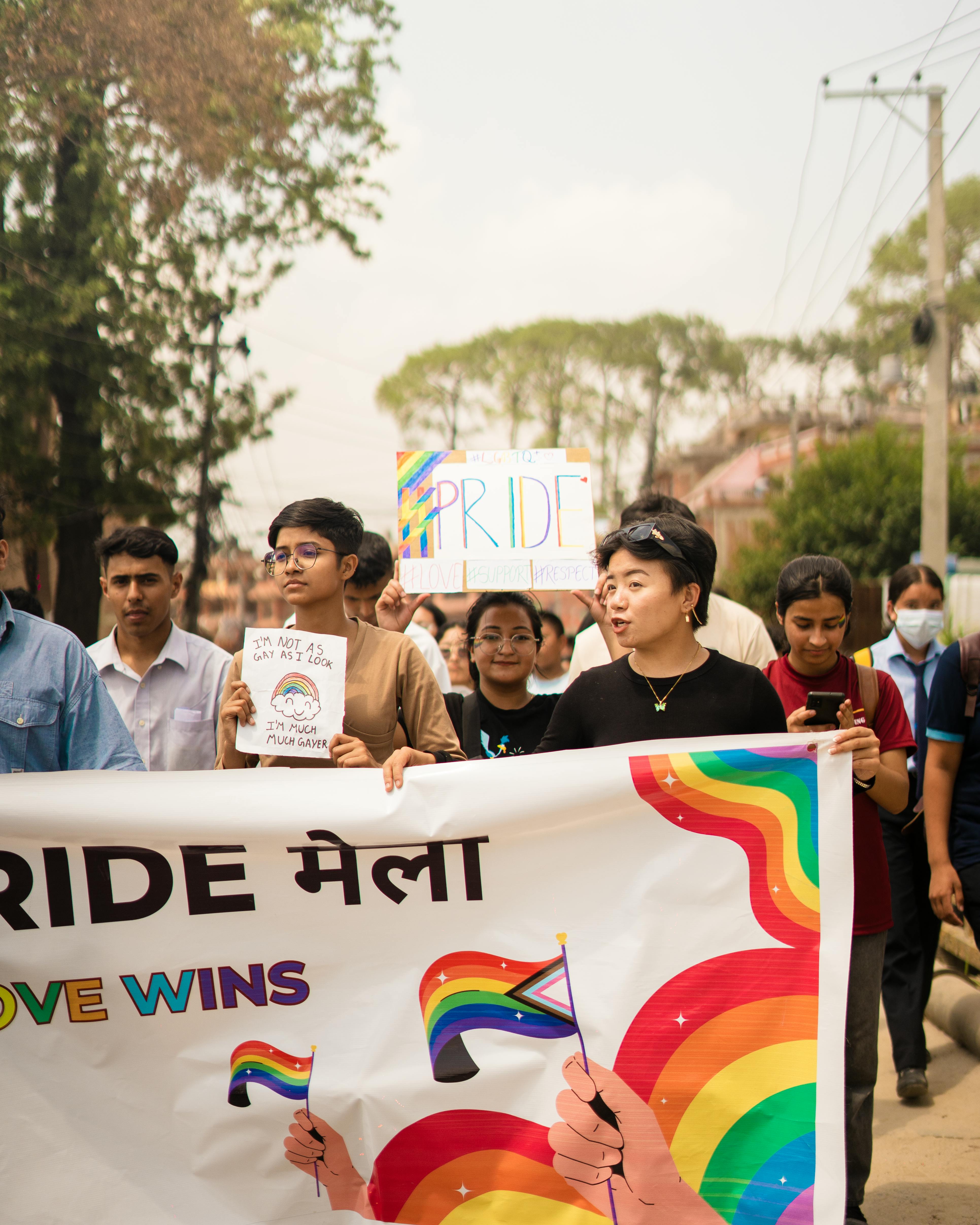 A Group of Young People Walking in a Pride Parade · Free Stock Photo