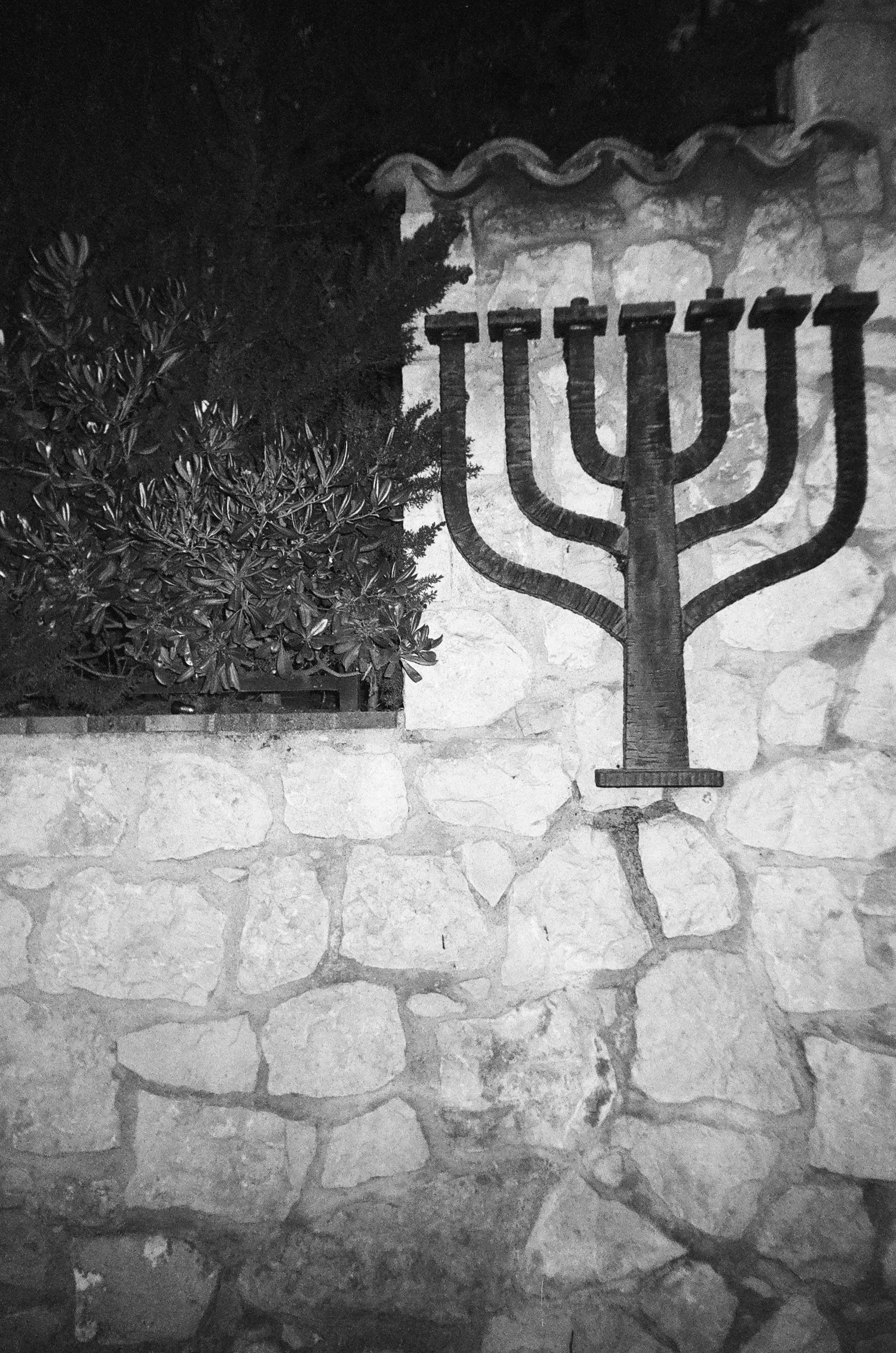 Ornament in the Shape of a Menorah on a Stone Fence · Free Stock Photo