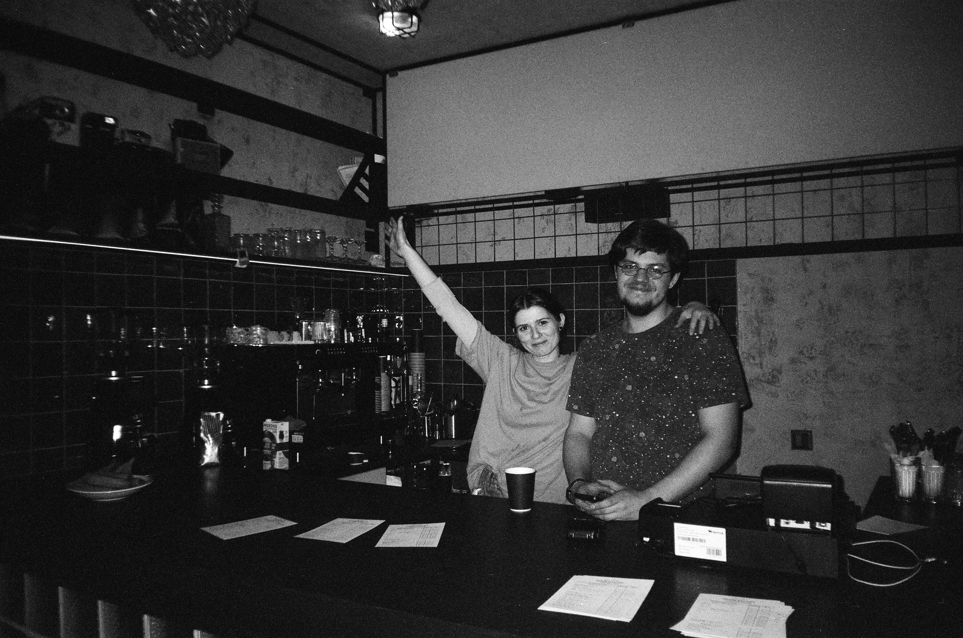Smiling Woman and Man Standing by Counter · Free Stock Photo