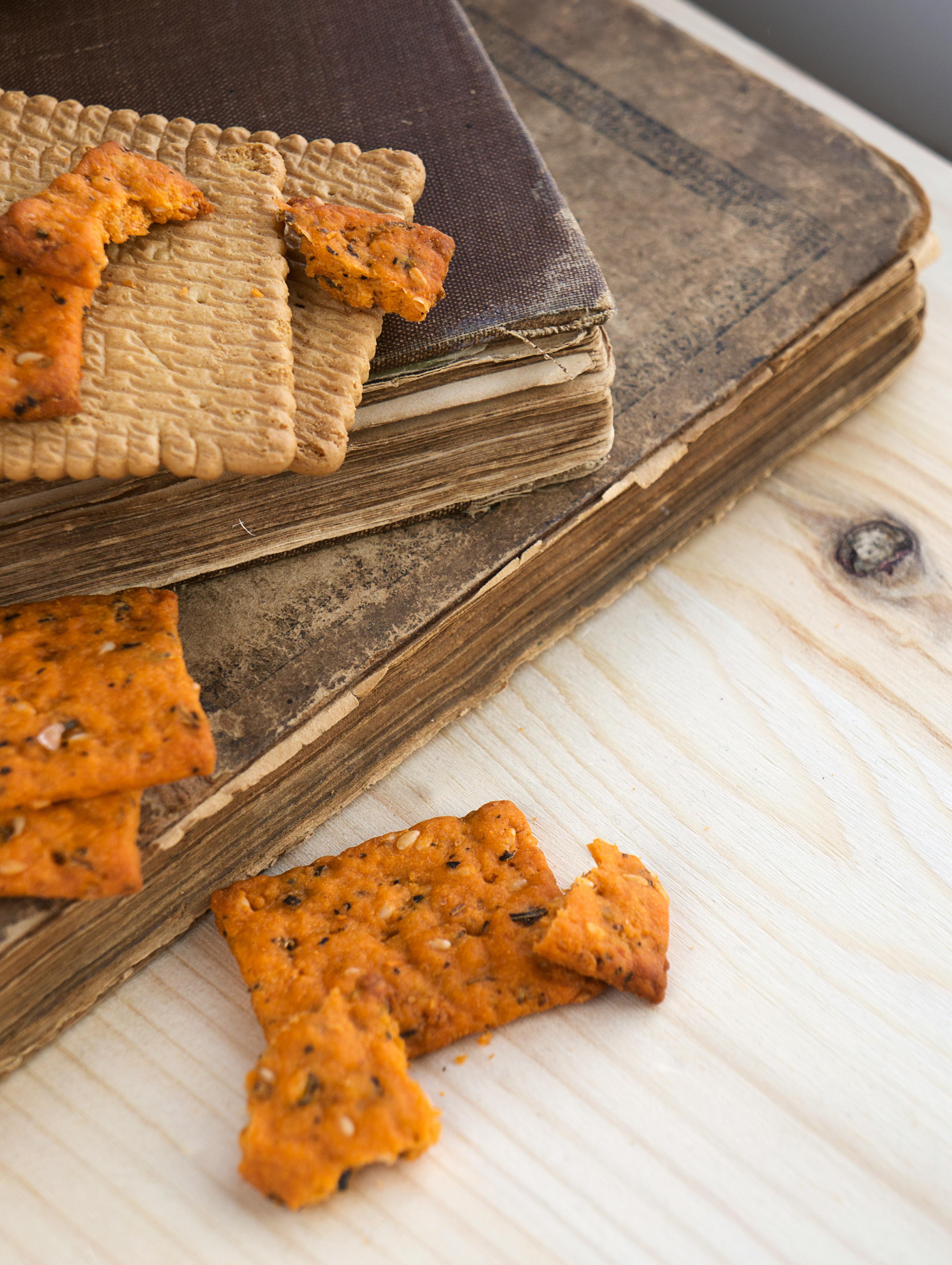 A stack of crackers on top of an old book · Free Stock Photo