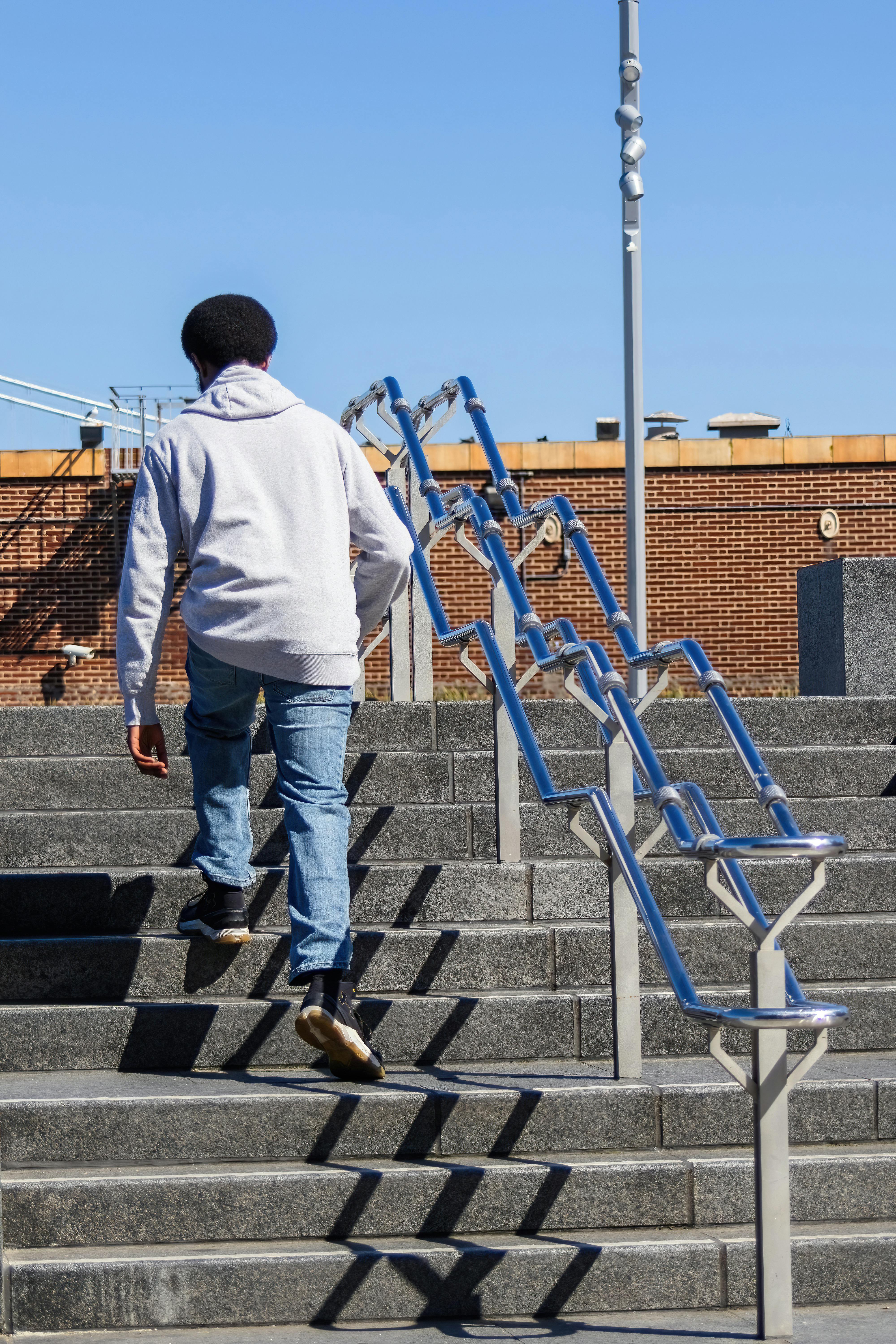 Man Walking on Gray Stairs · Free Stock Photo