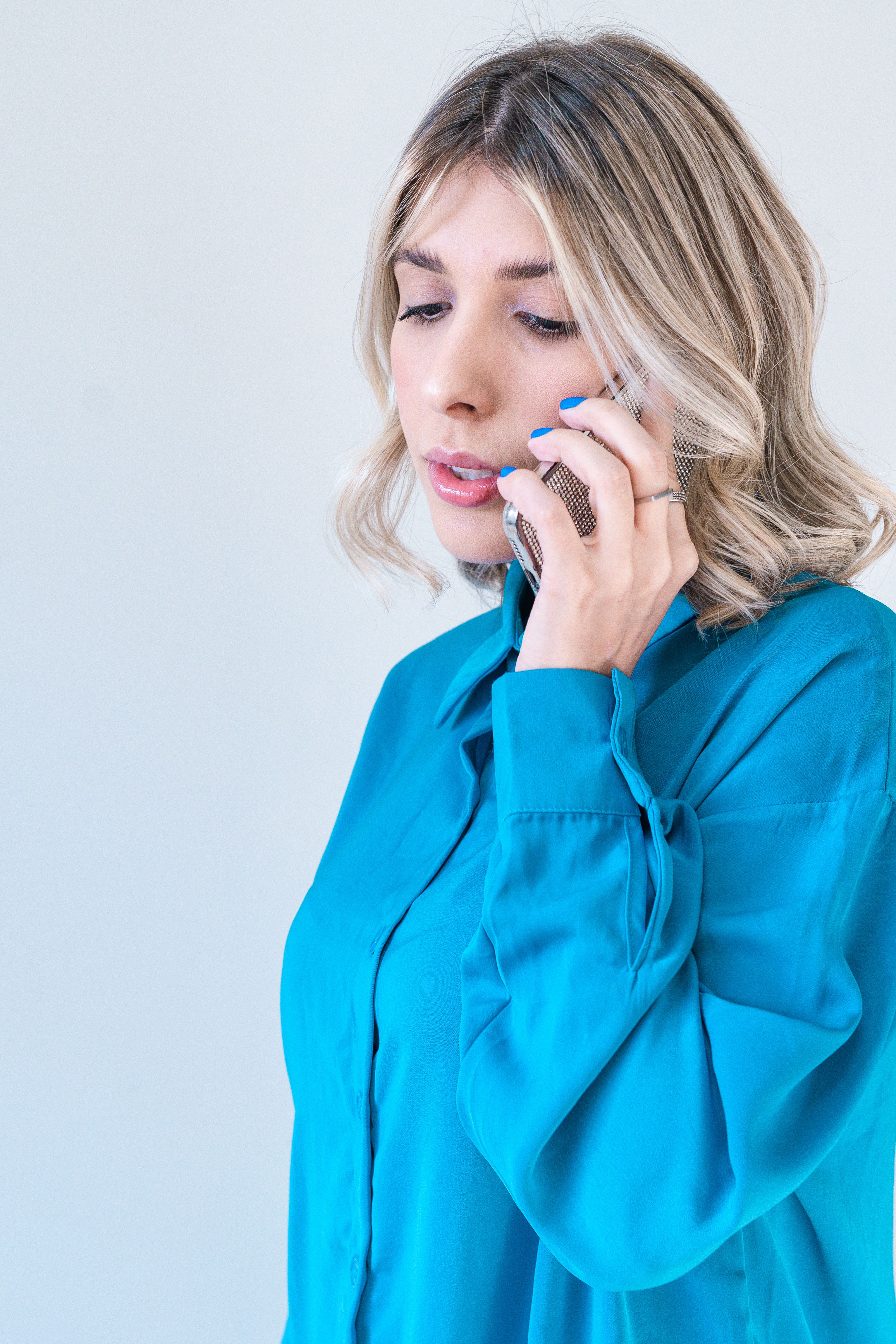 Blonde Woman in Blue Shirt Talking on Phone · Free Stock Photo