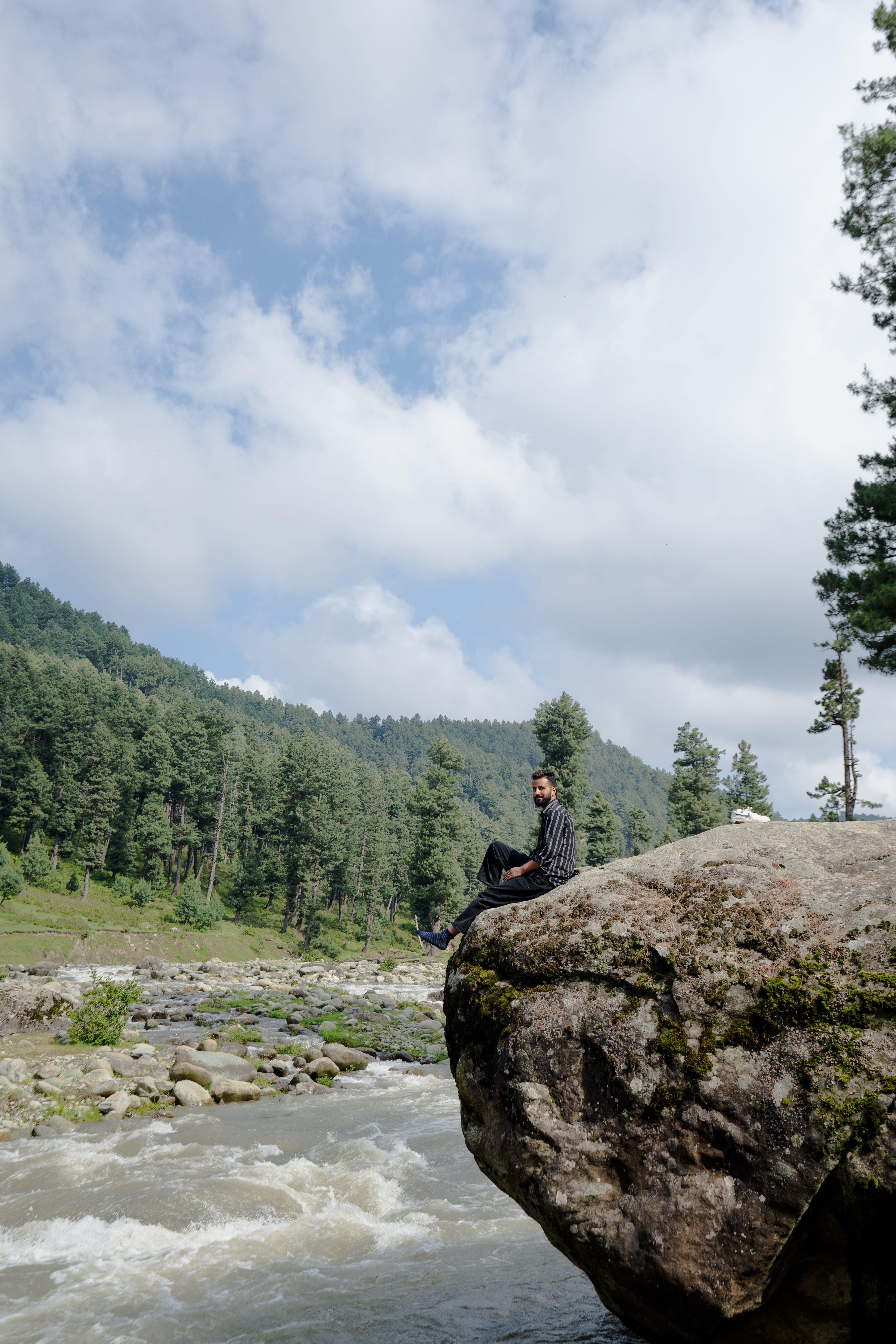Man Sitting on Rock over Stream · Free Stock Photo