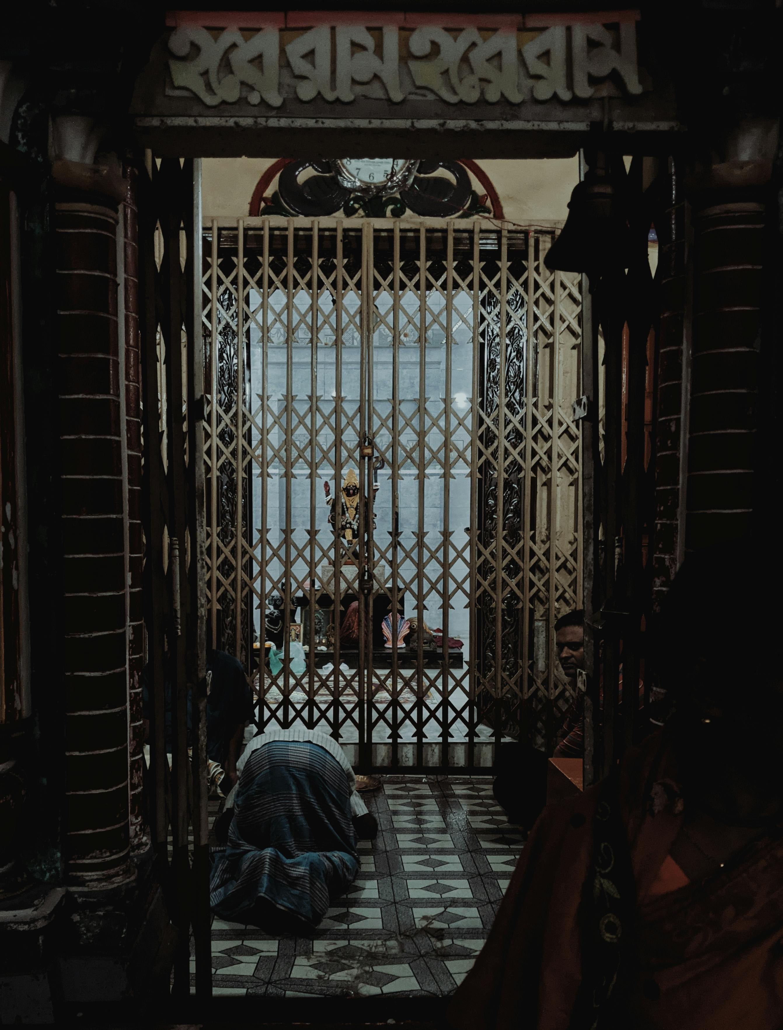 Person Prostrating in a Shrine · Free Stock Photo