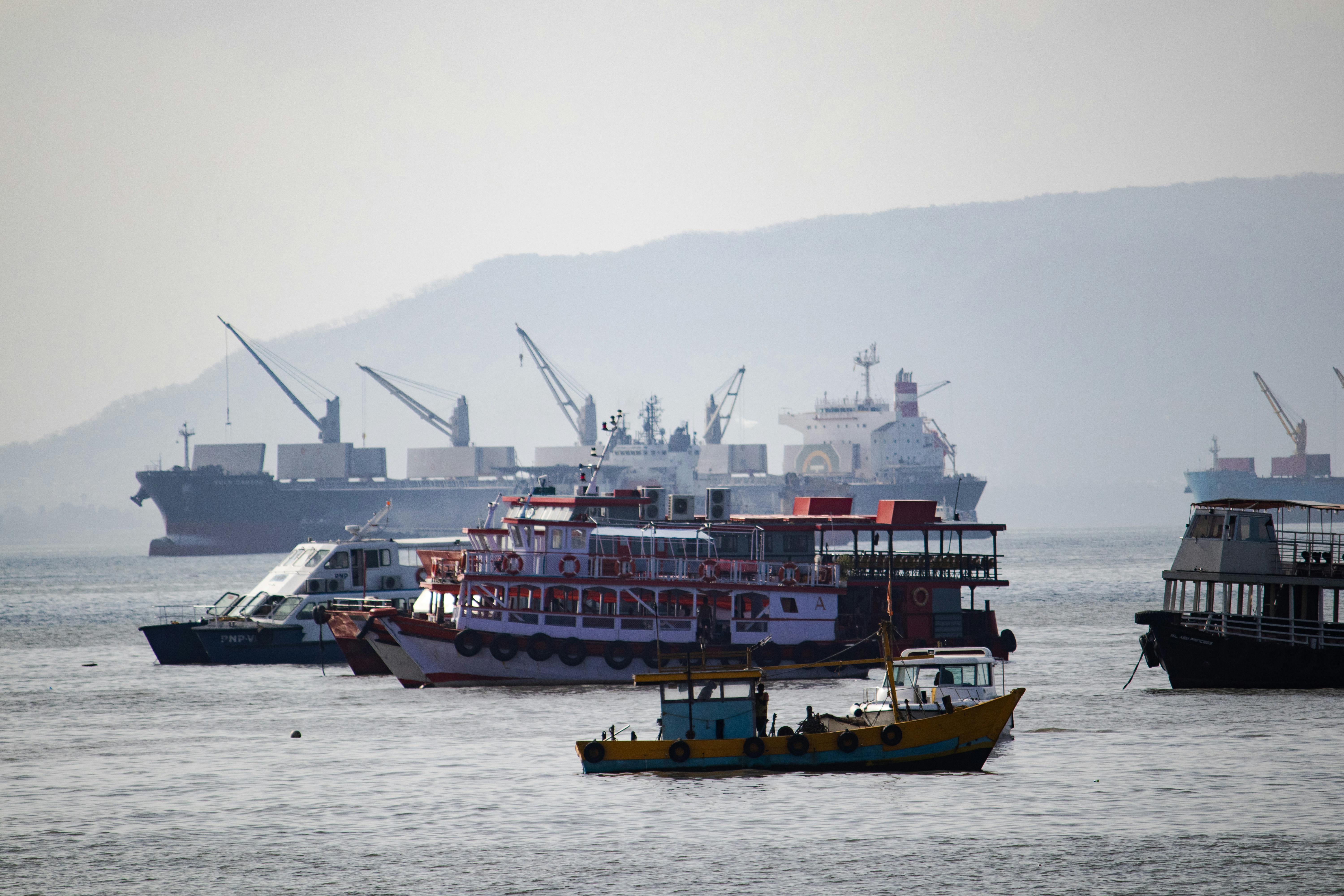 Boats and Cargo Ship on Shore of Arabian Sea in India · Free Stock Photo
