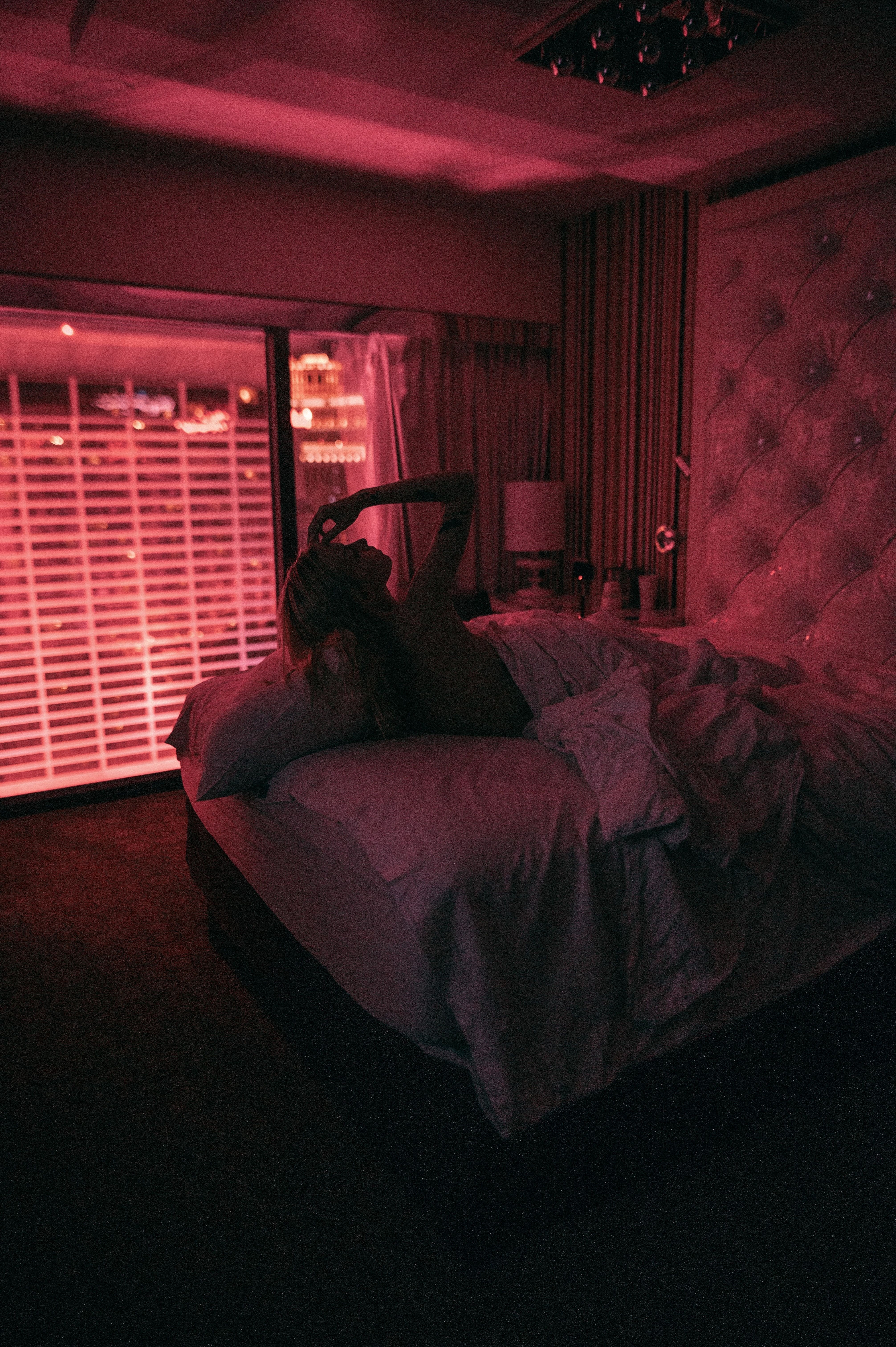 Woman Lying Down on Bed in Red Light · Free Stock Photo