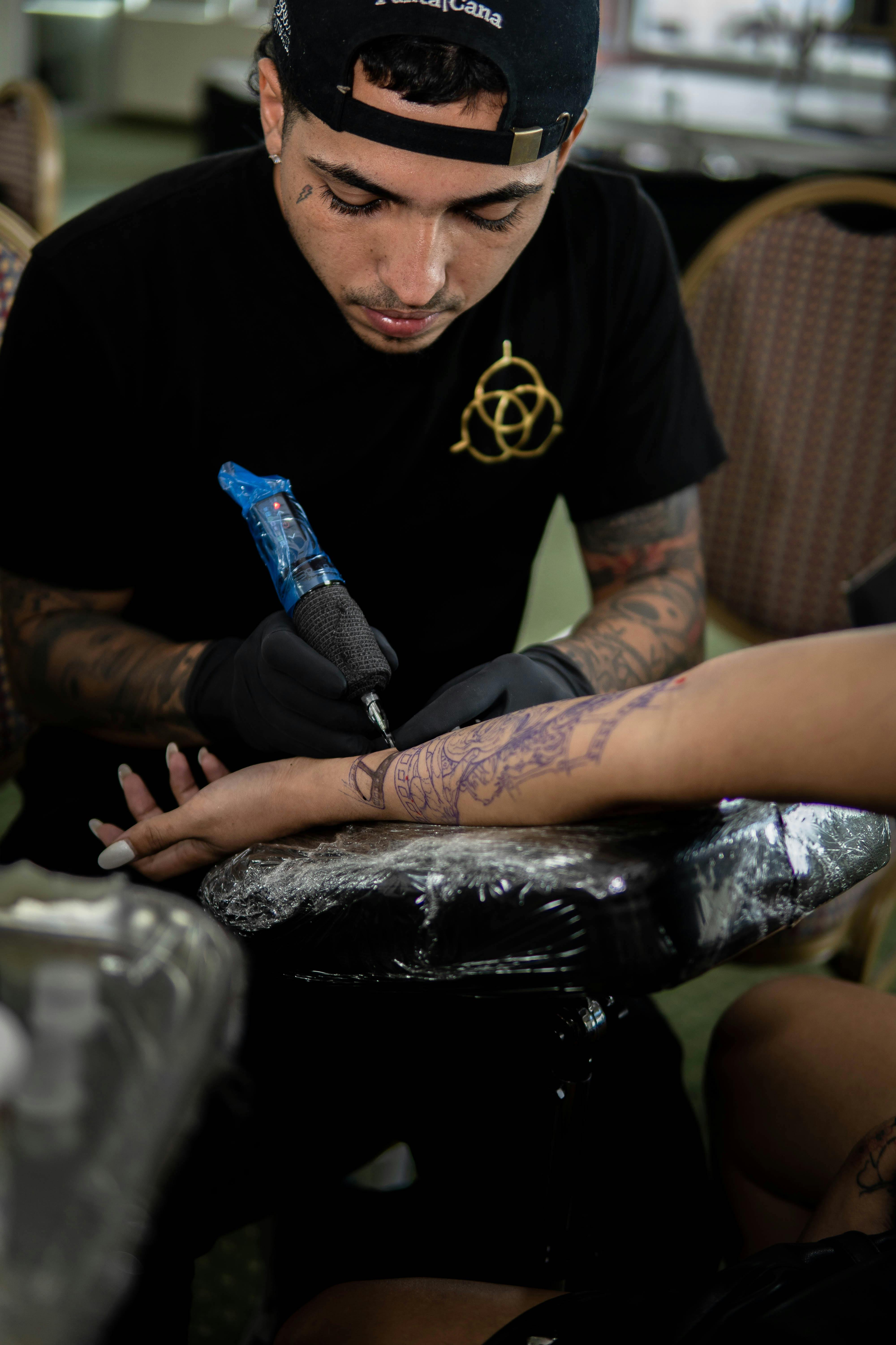 Man Drawing a Tattoo · Free Stock Photo
