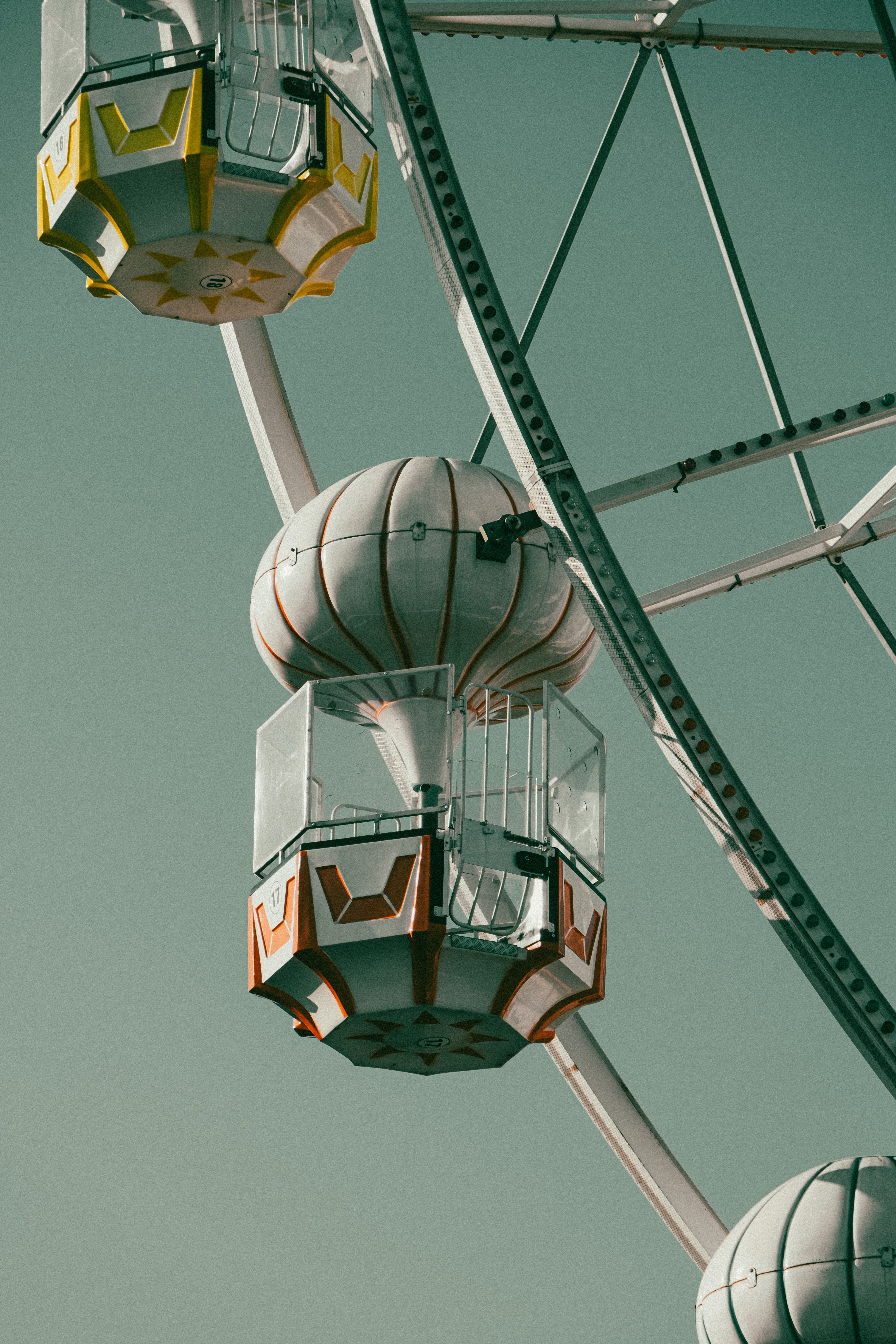 Yellow Ferris Wheel Gondola Against Blue Sky · Free Stock Photo