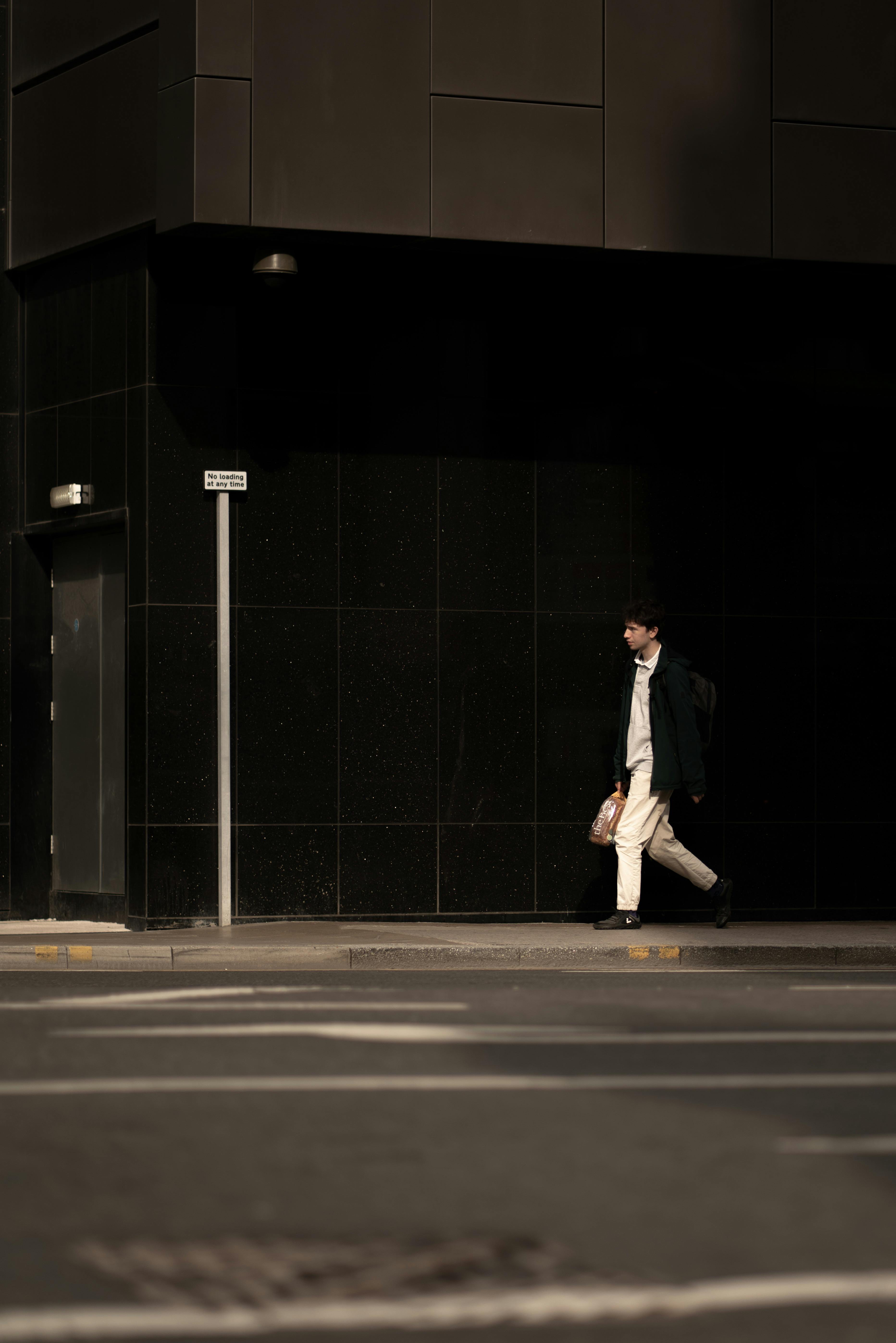 Woman Walking past a Glowing Sign · Free Stock Photo