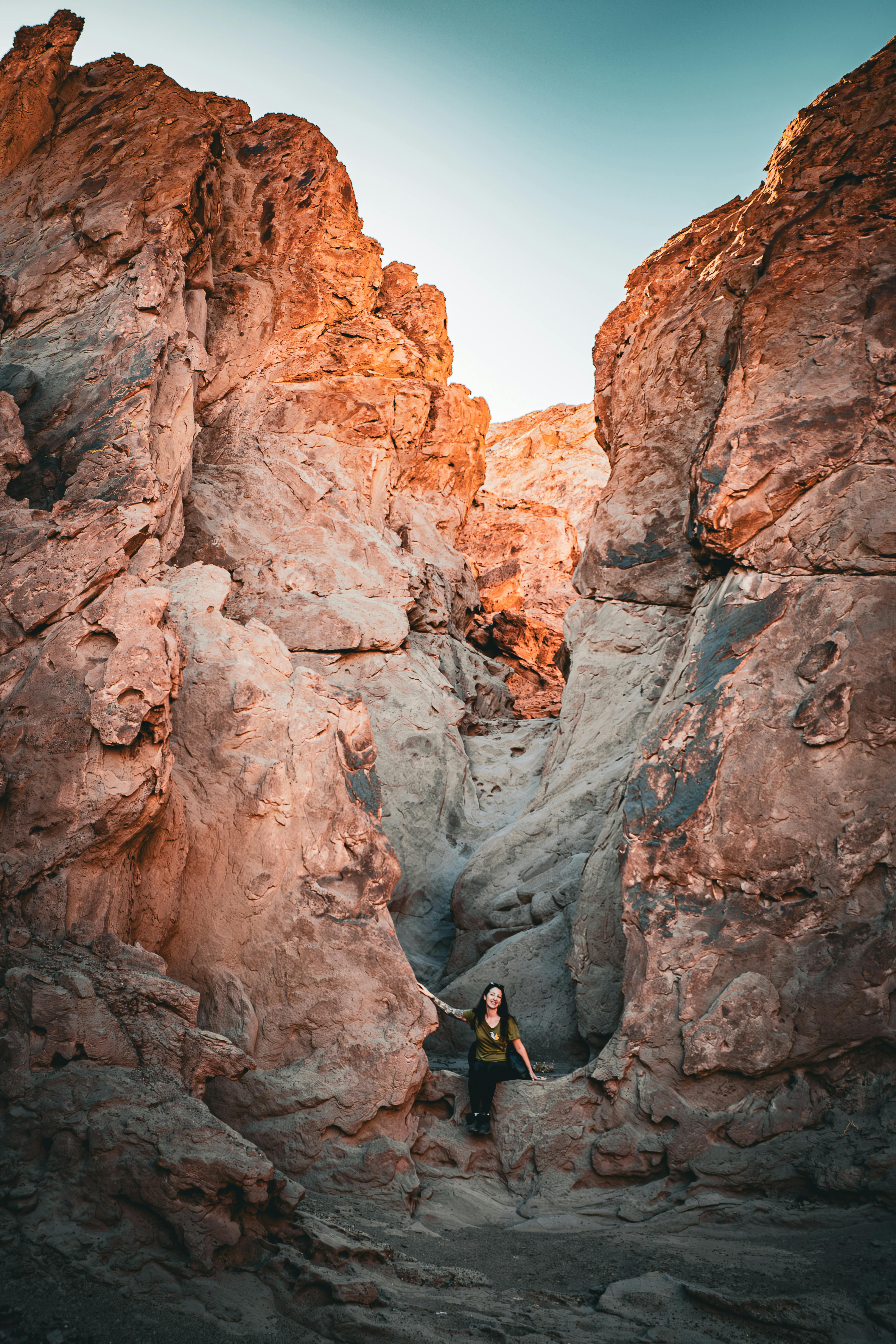 Woman Standing in Gap between Rocks · Free Stock Photo