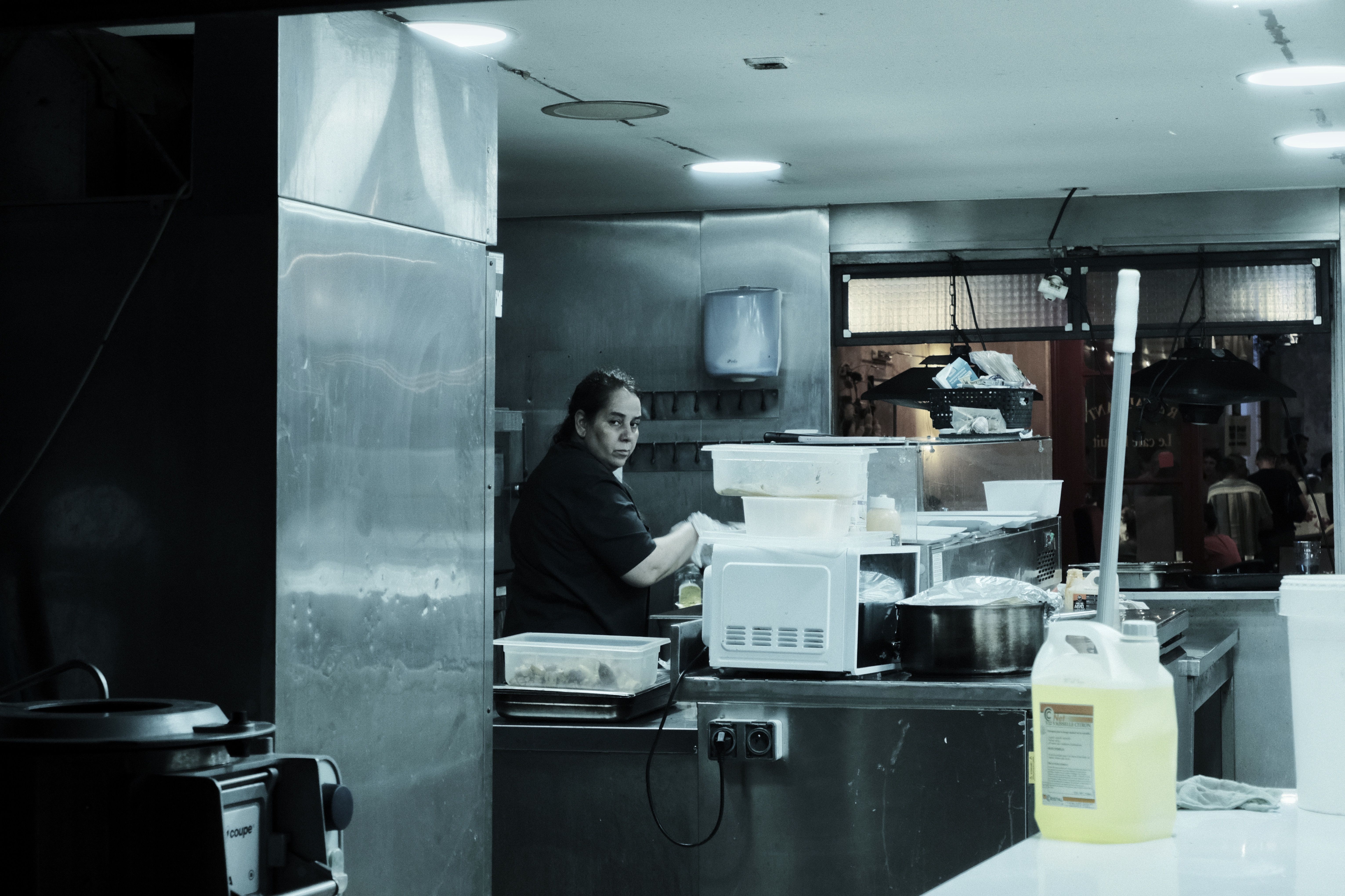 A Woman in a Restaurant Kitchen · Free Stock Photo