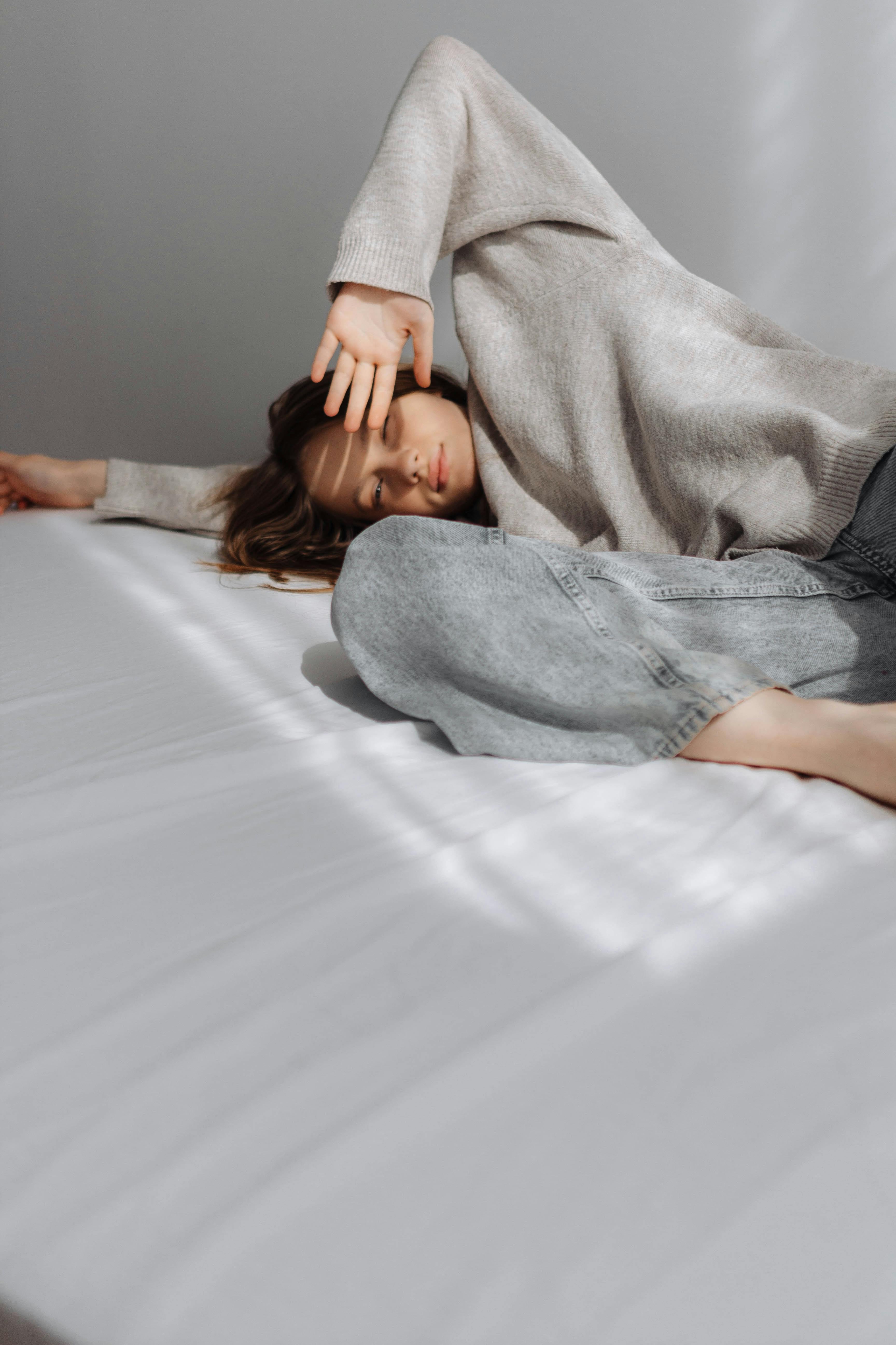 Woman Lying on Mattress and Covering Eyes from Sunlight · Free Stock Photo